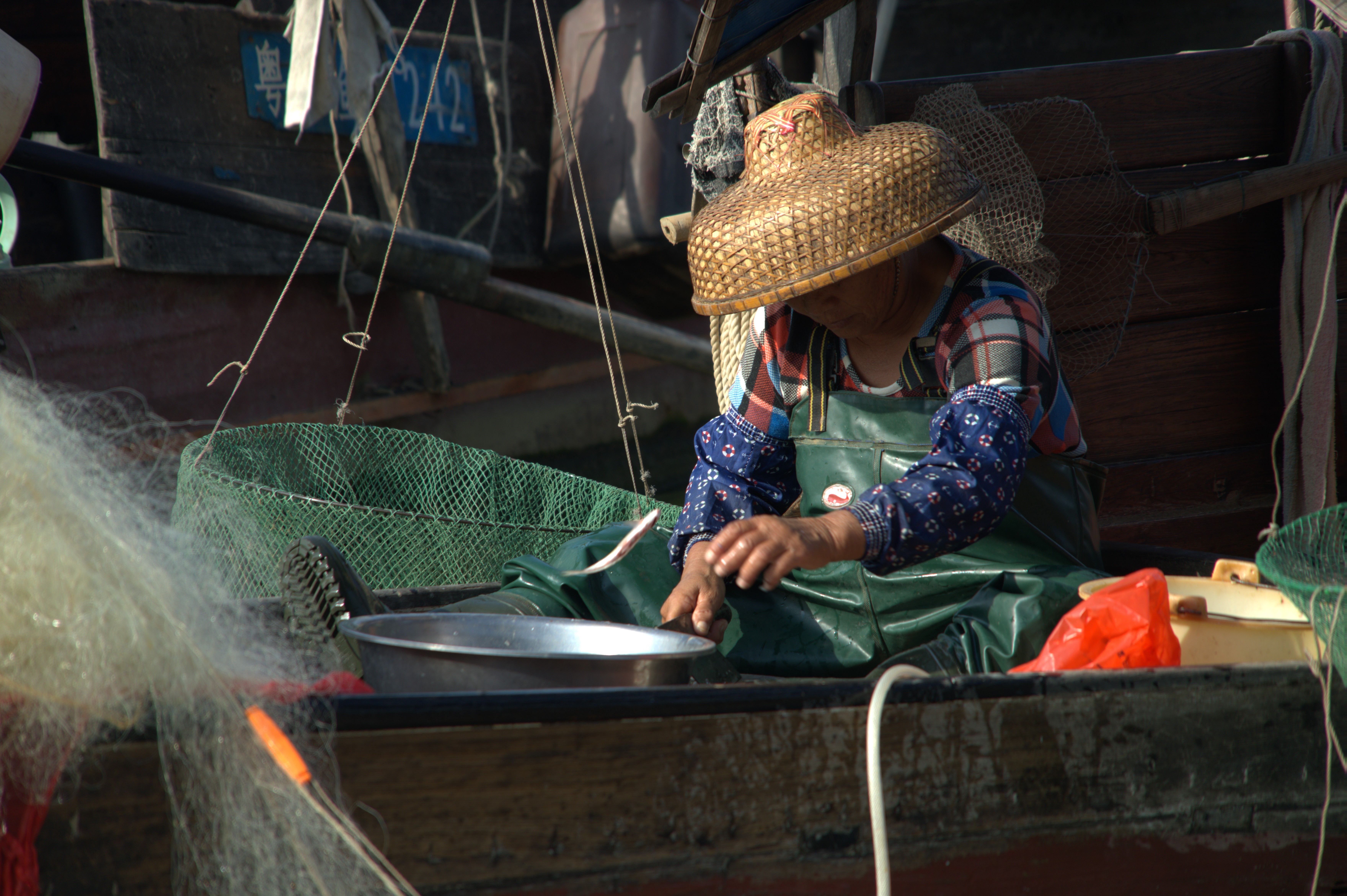 Traditional Fisherman Working on Wooden Boat · Free Stock Photo