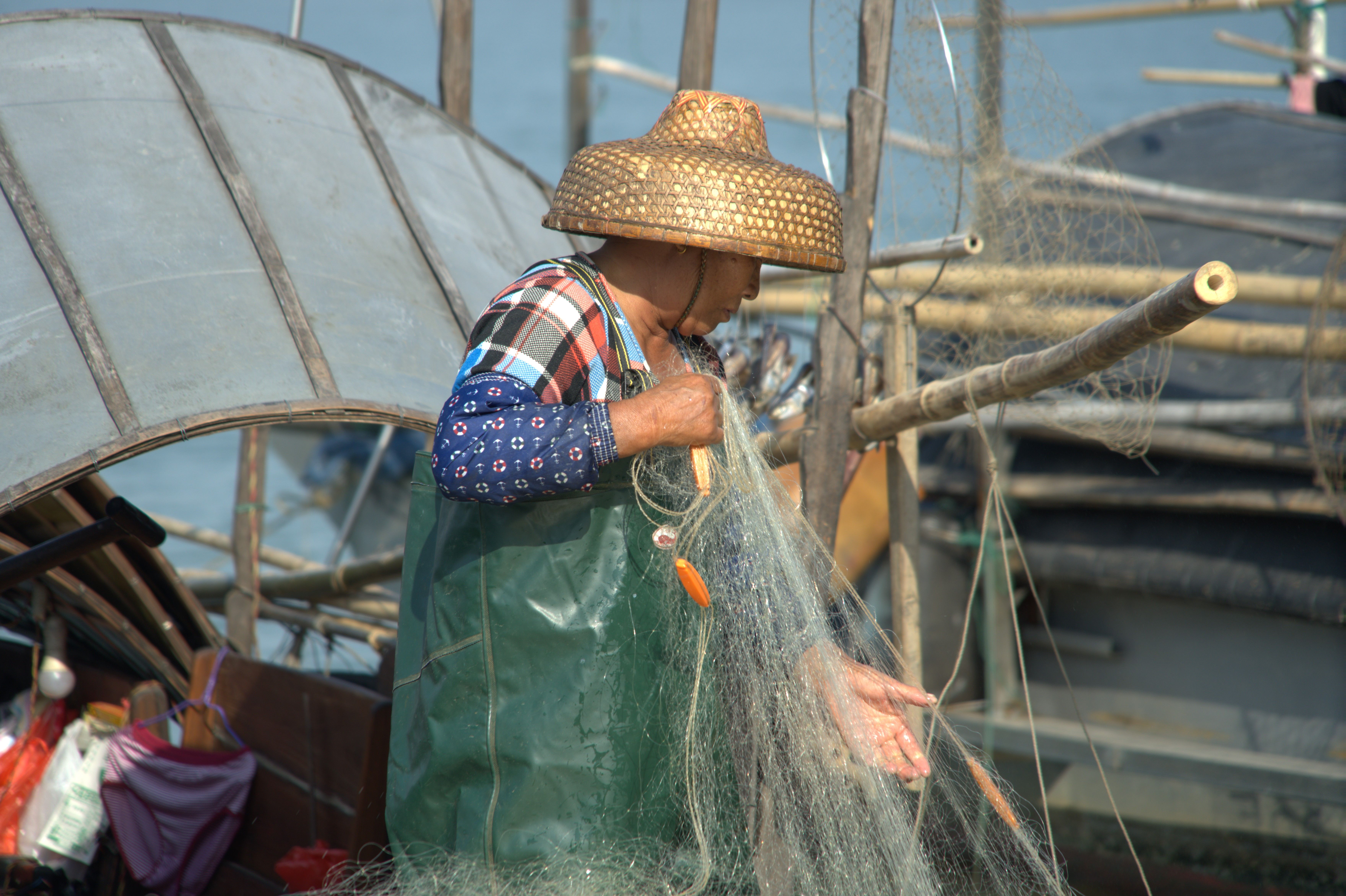 Traditional Fisherman with Net on a Boat · Free Stock Photo
