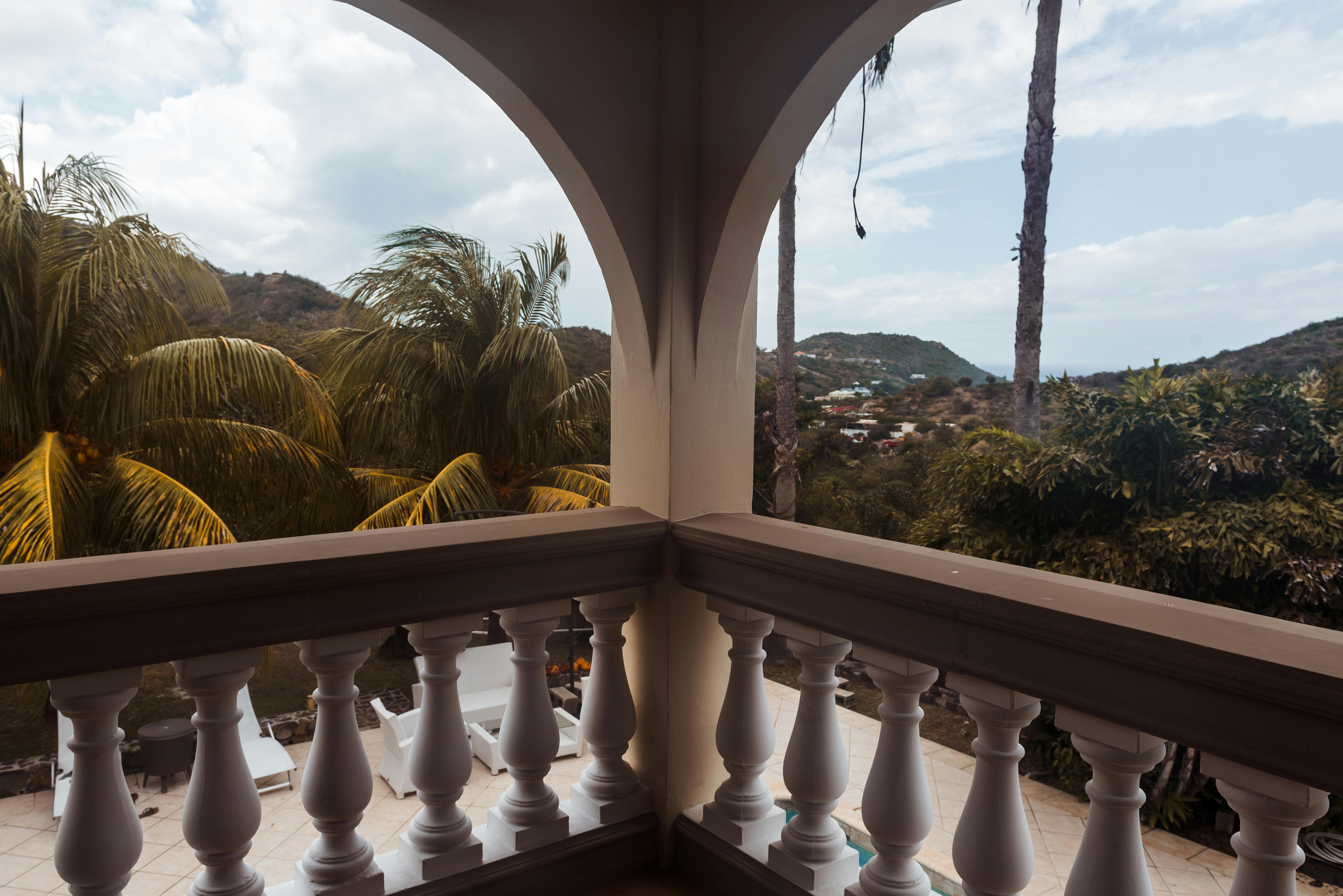 Photo of Balcony Across Trees Under Cloudy Sky · Free Stock Photo