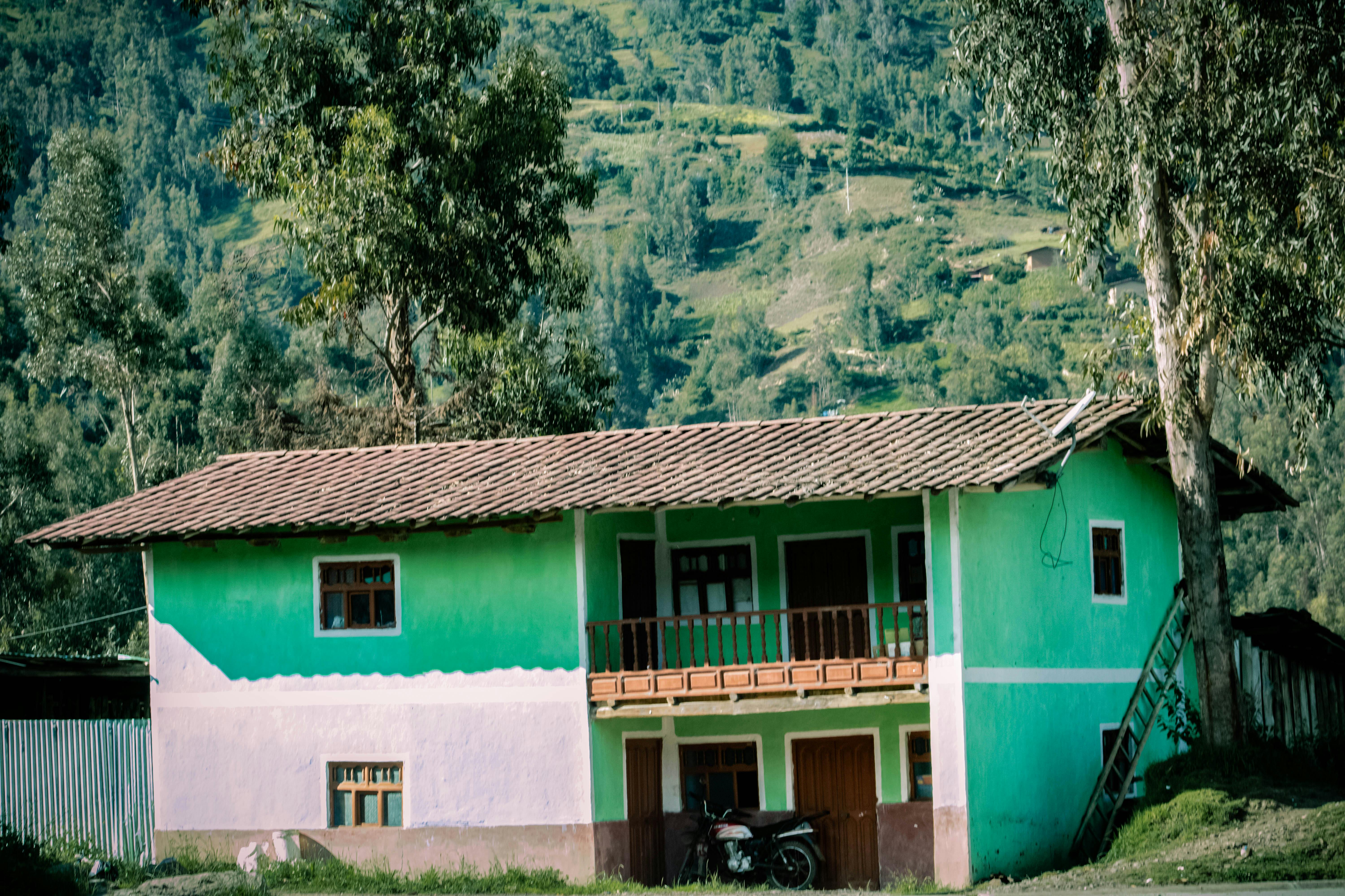 Two-Story Green House in Mountainous Landscape · Free Stock Photo