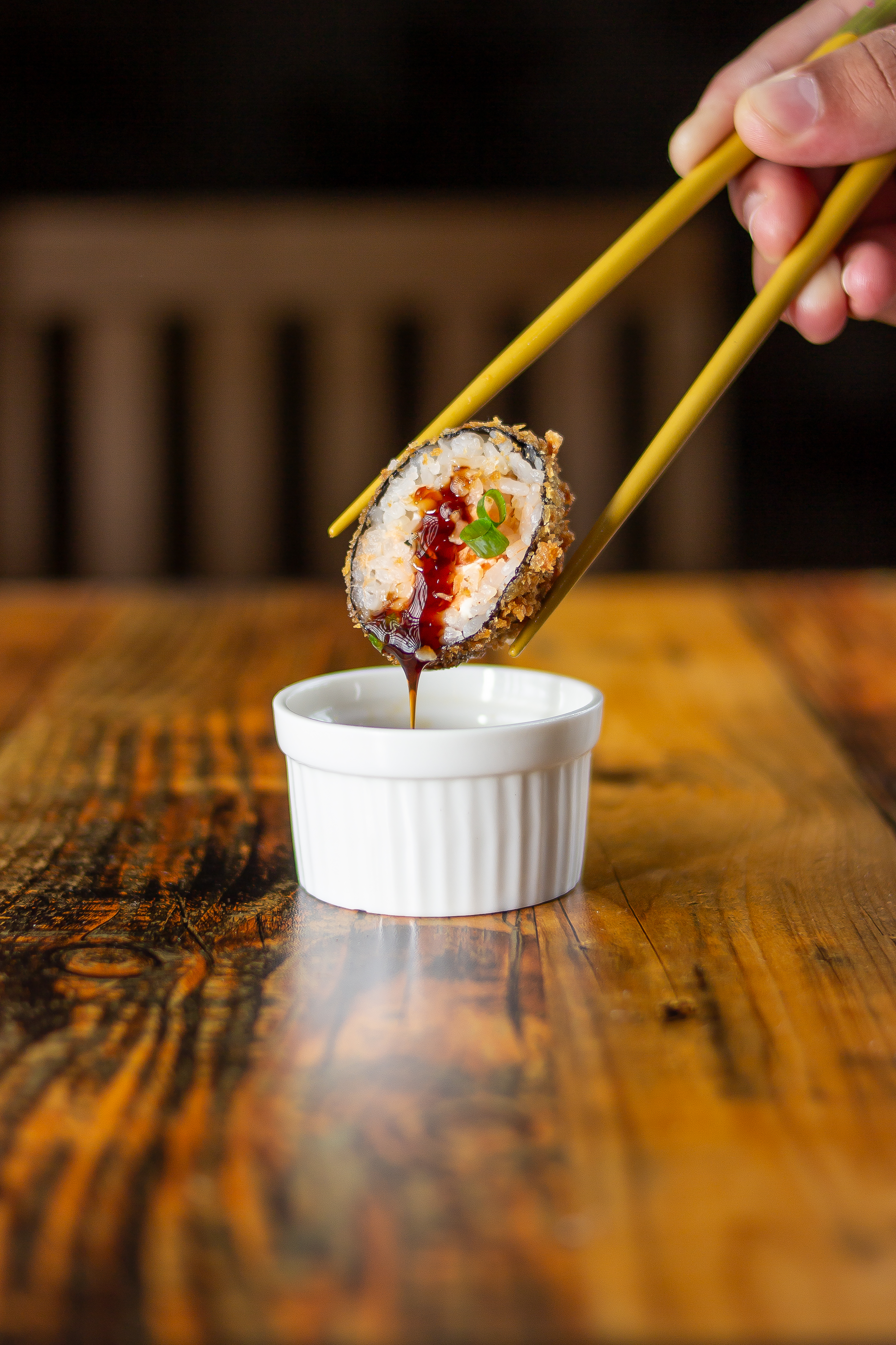 Golden Sushi Roll with Soy Sauce on Rustic Table · Free Stock Photo