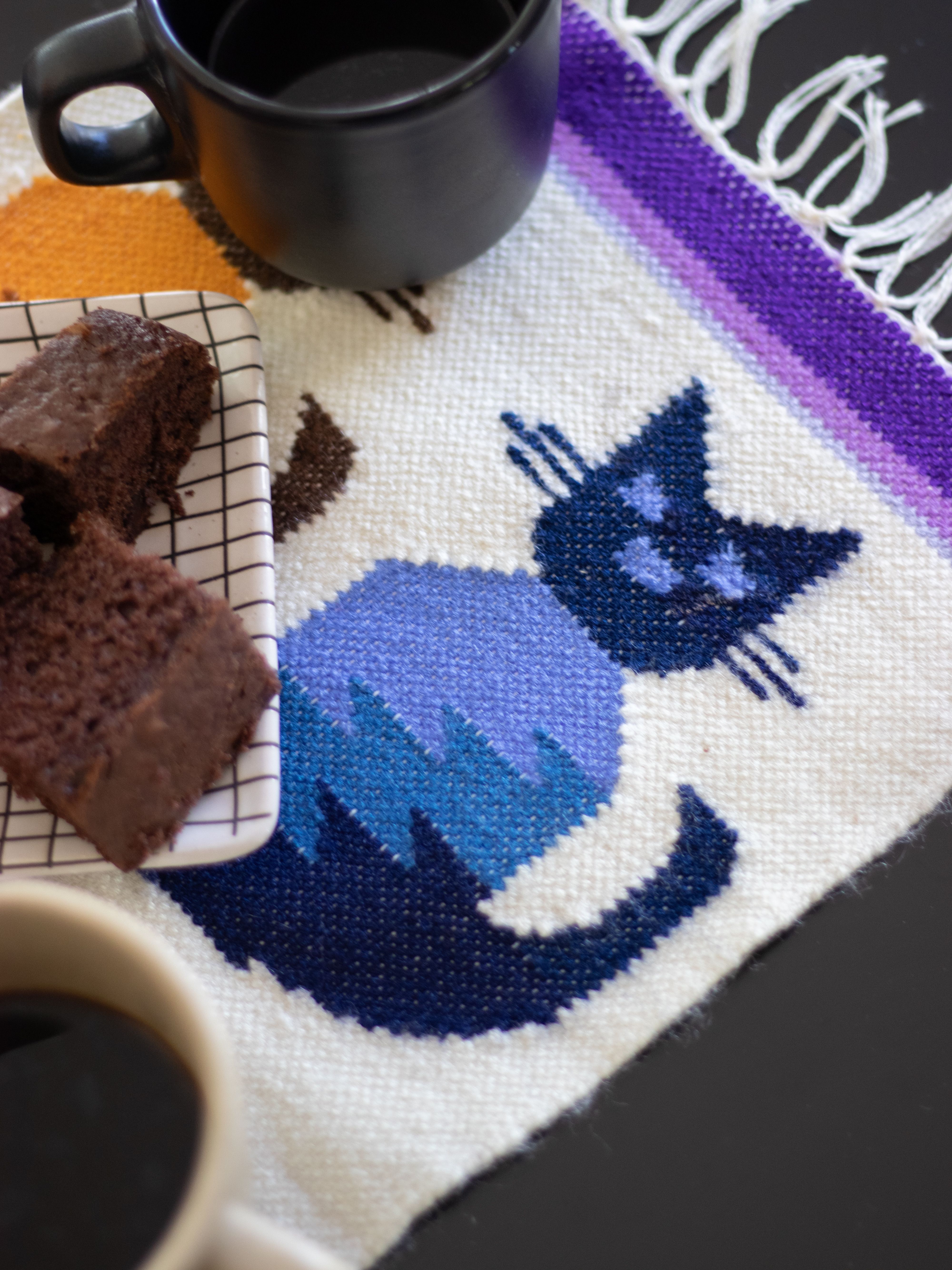 Artisanal Woven Cat Design Textile with Coffee · Free Stock Photo