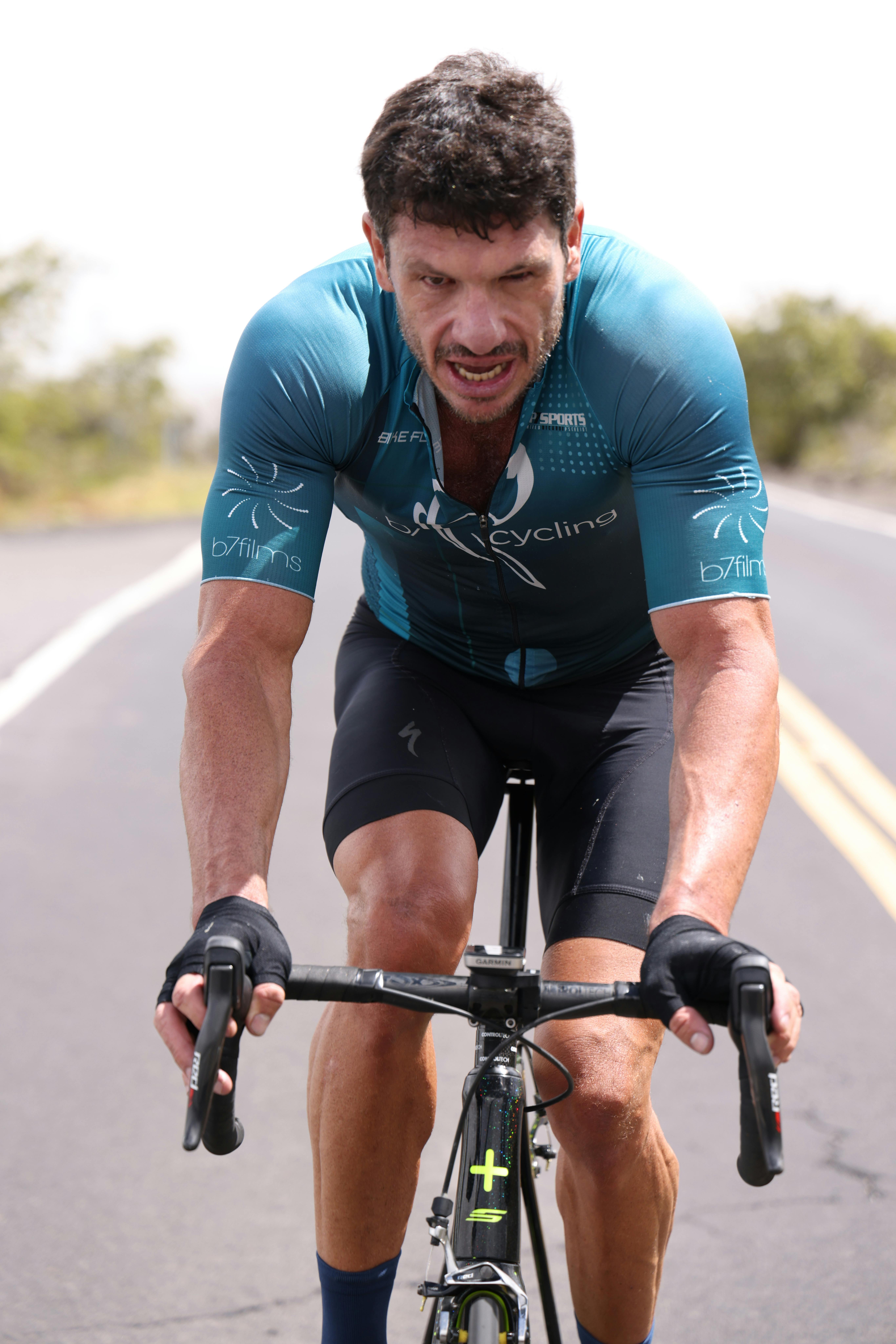 Focused Cyclist Racing Outdoors on Sunny Day · Free Stock Photo