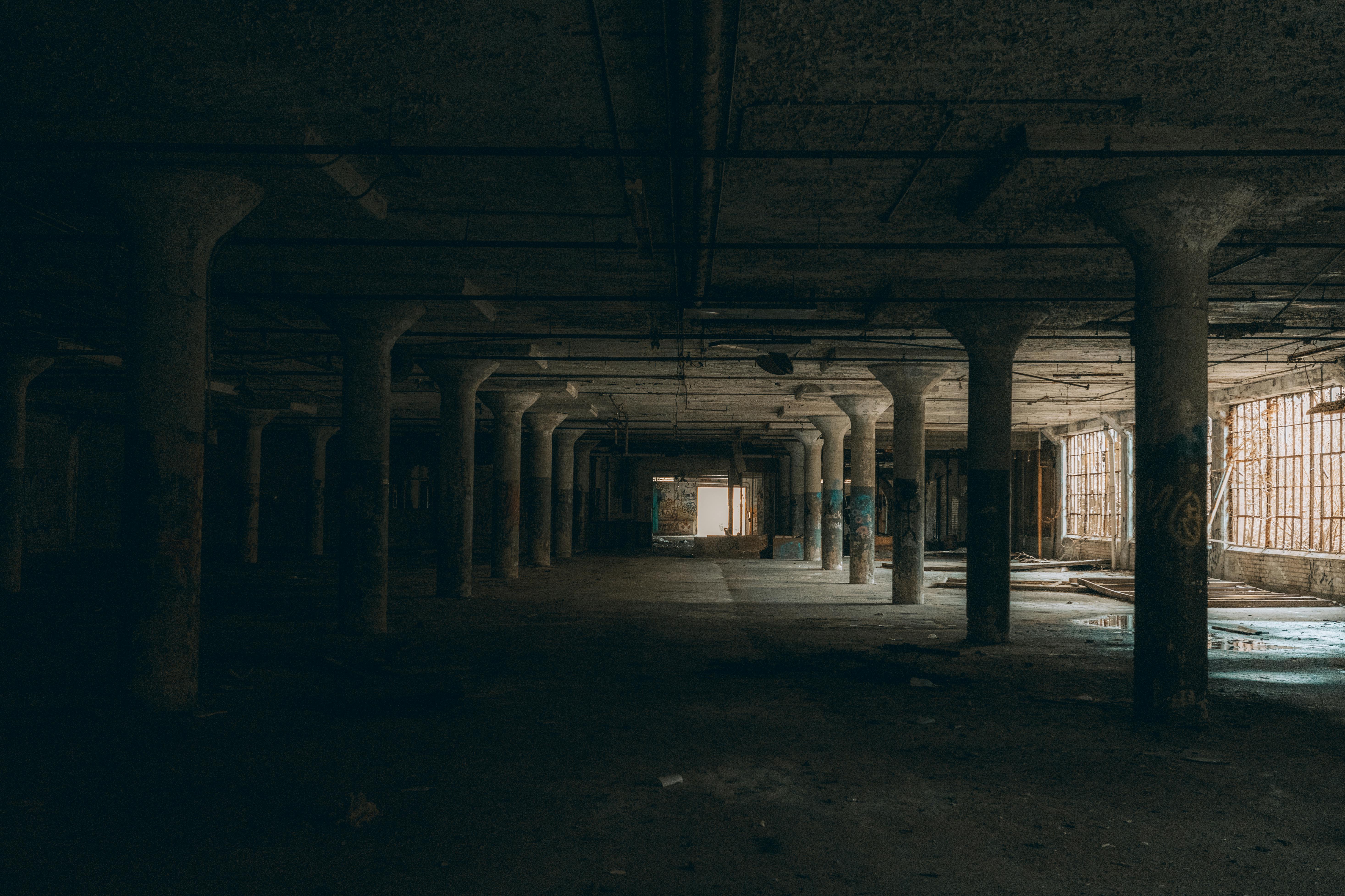 Moody Abandoned Warehouse Interior with Columns · Free Stock Photo