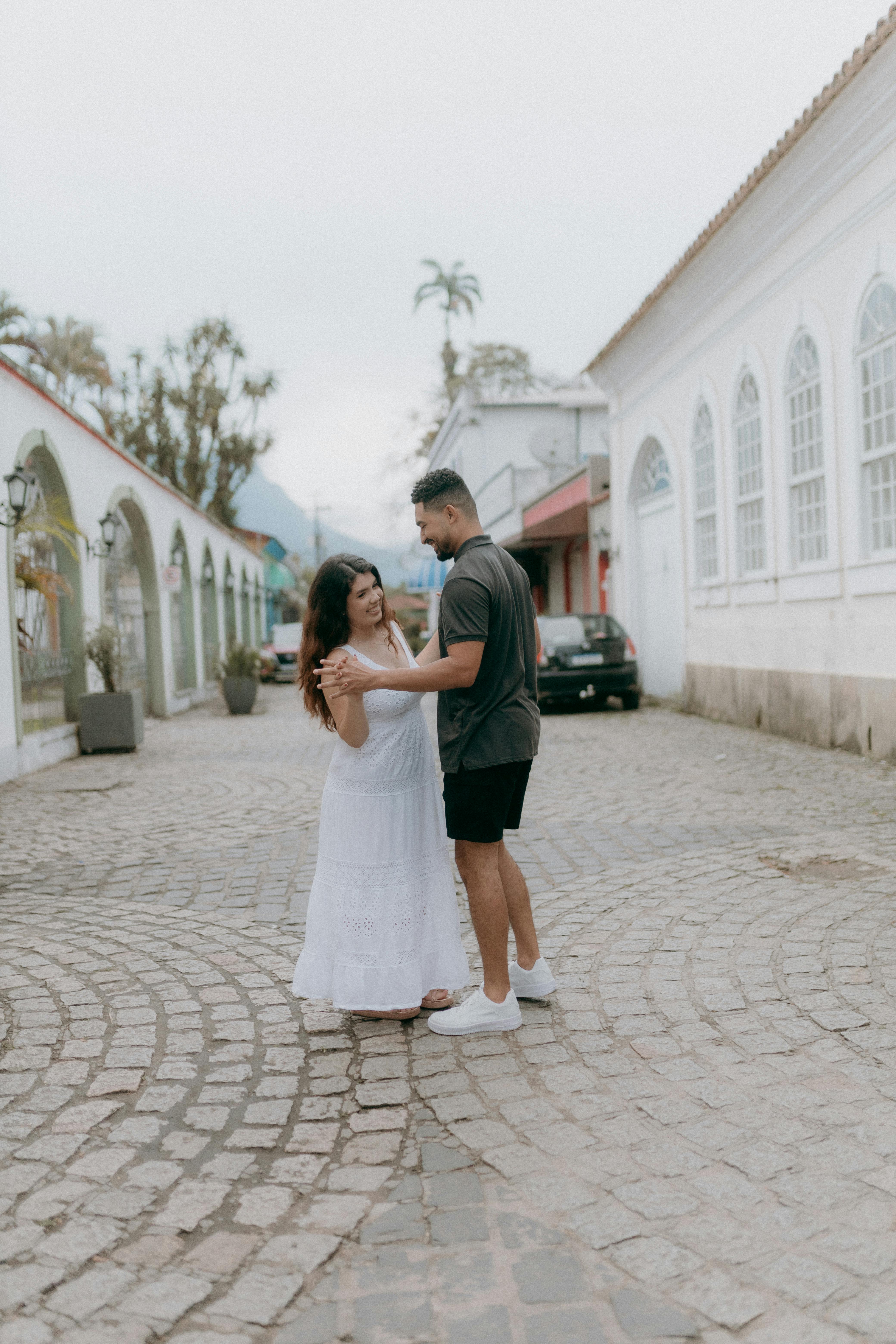 Romantic Couple Dancing on Cobblestone Street · Free Stock Photo