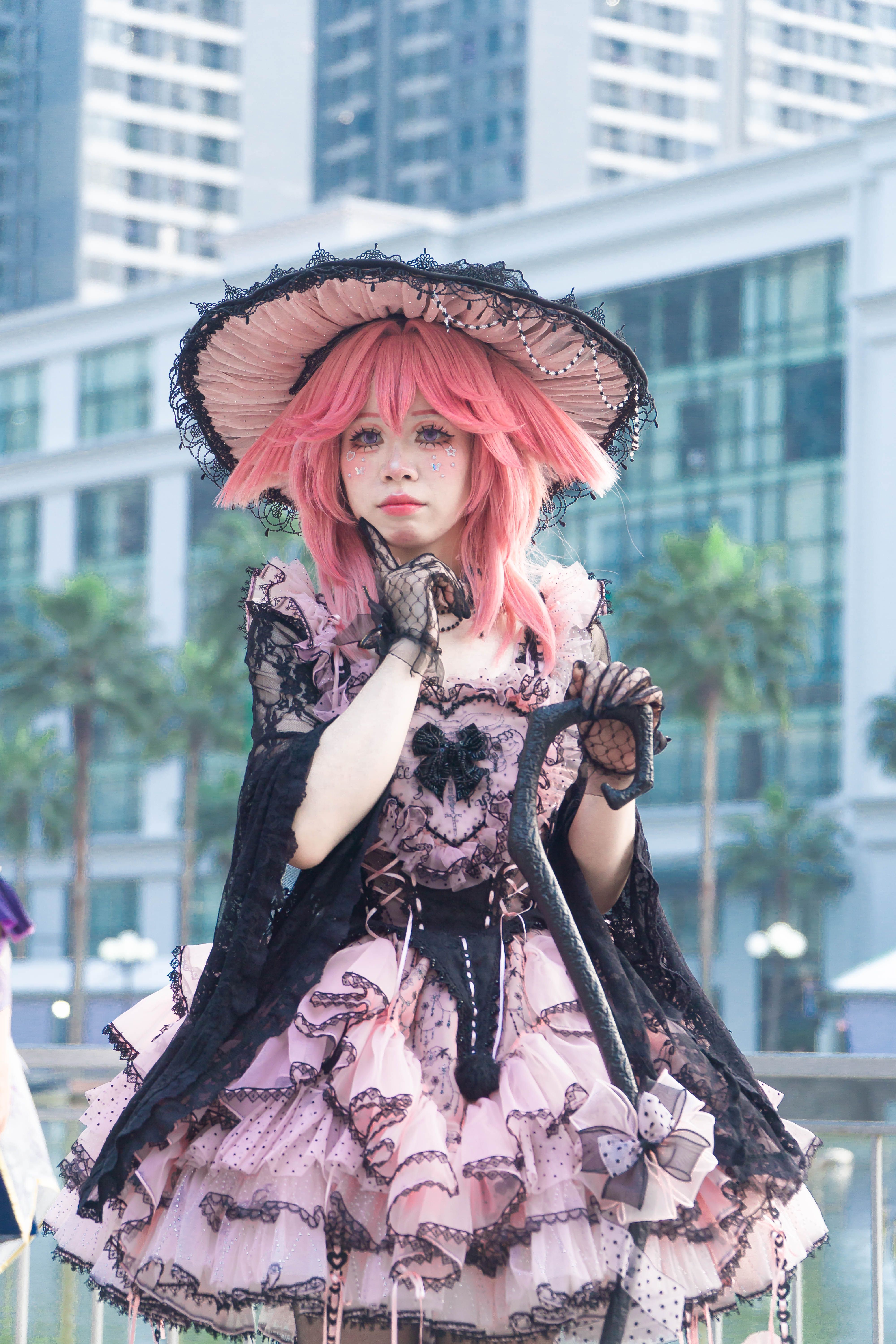 Elegant Cosplay Portrait with Pink Hair in Urban Setting · Free Stock Photo