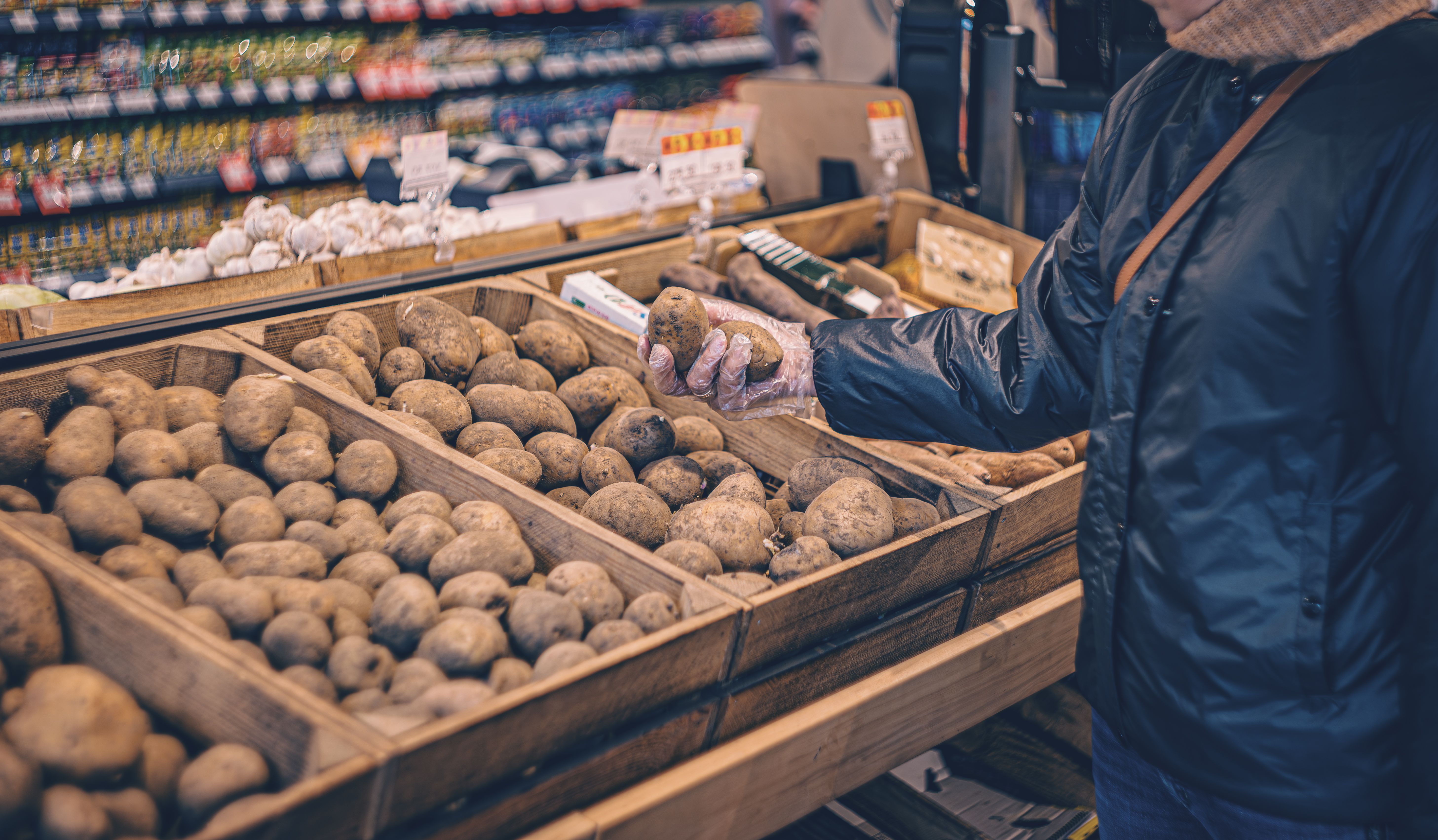 Person Selecting Potatoes at Grocery Store · Free Stock Photo