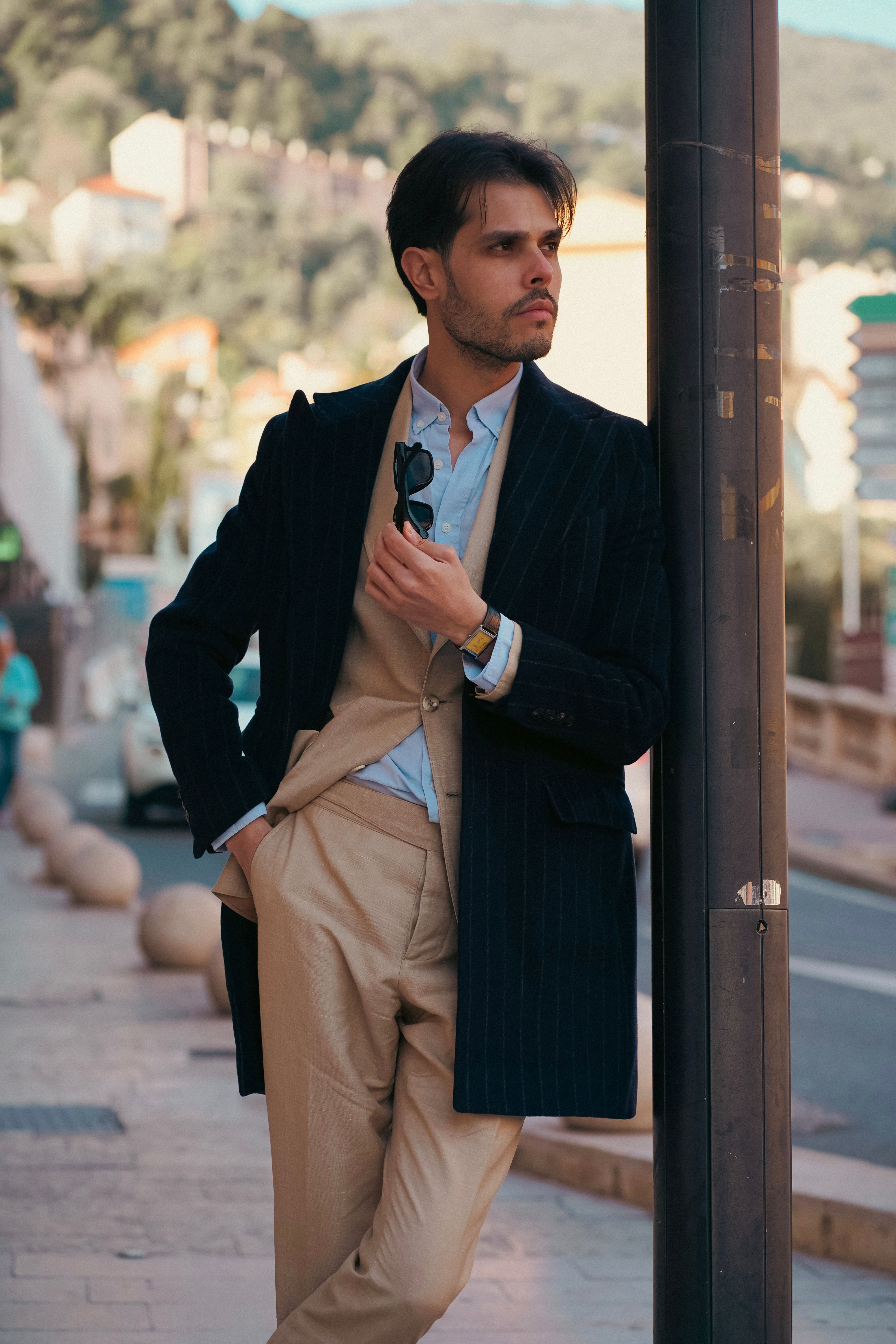 Stylish Man in Suit Leaning Against Post · Free Stock Photo