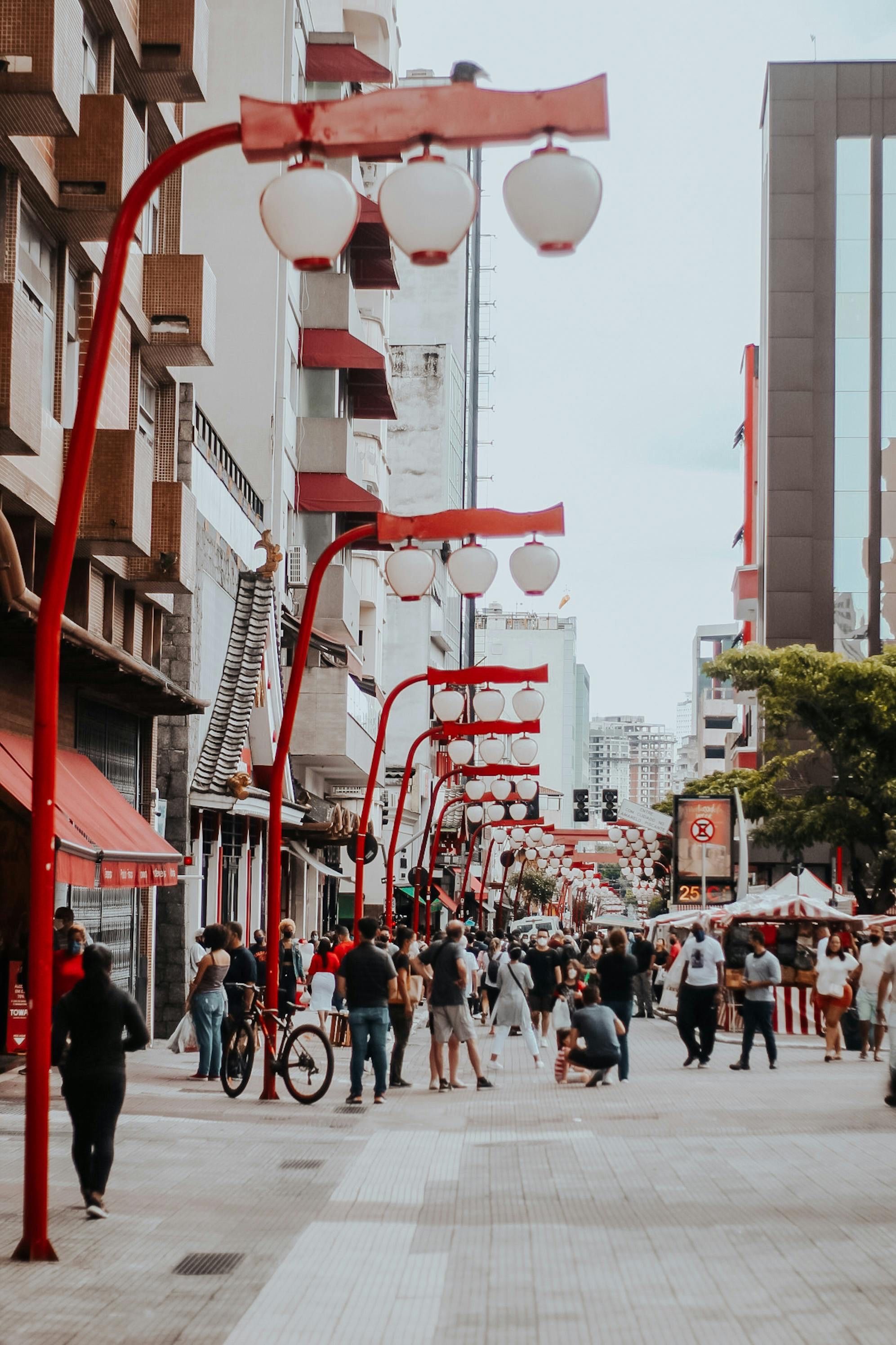 Bustling Urban Street with Red Lanterns and Crowd · Free Stock Photo