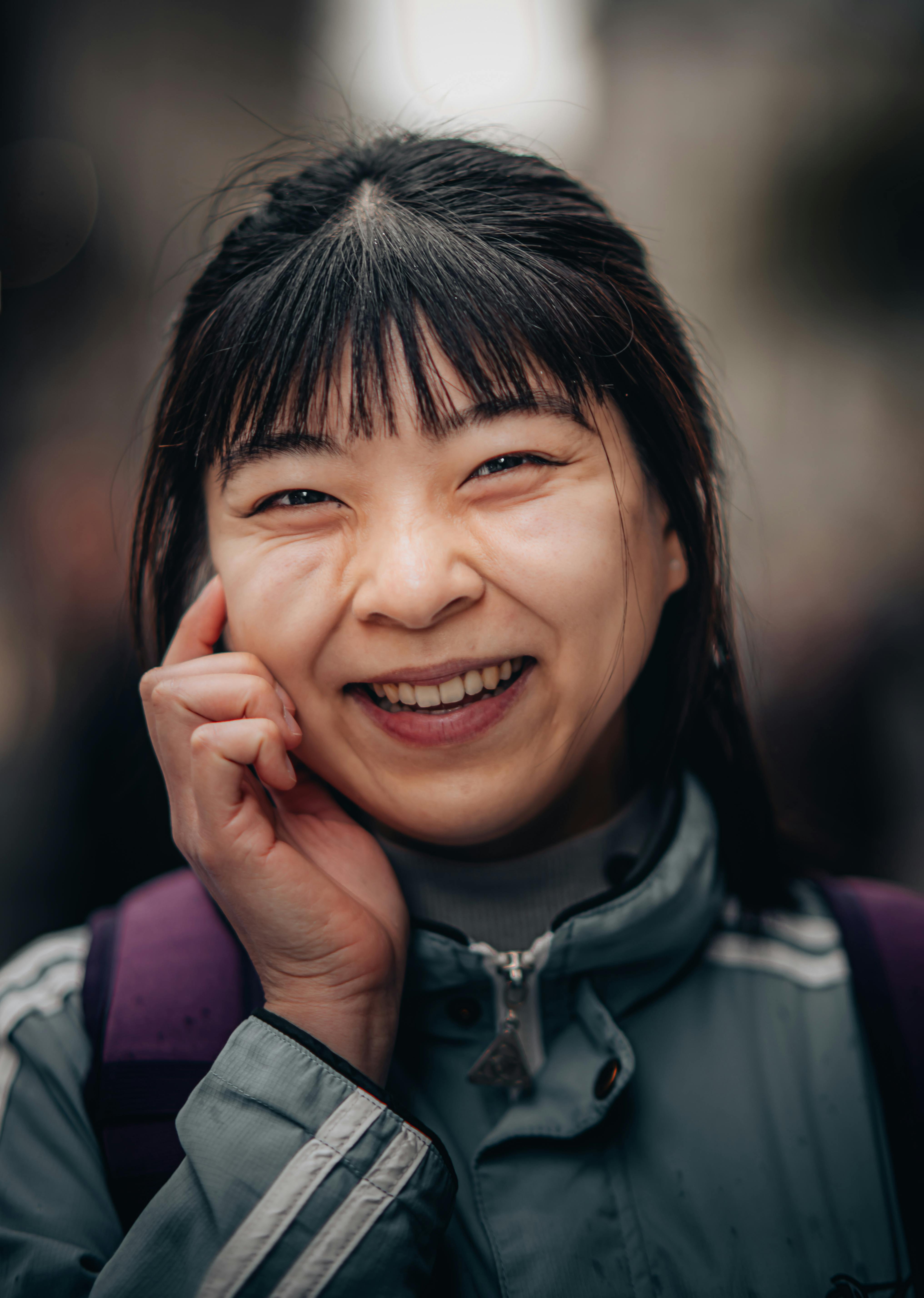 Cheerful Woman Smiling Outdoors on a City Street · Free Stock Photo