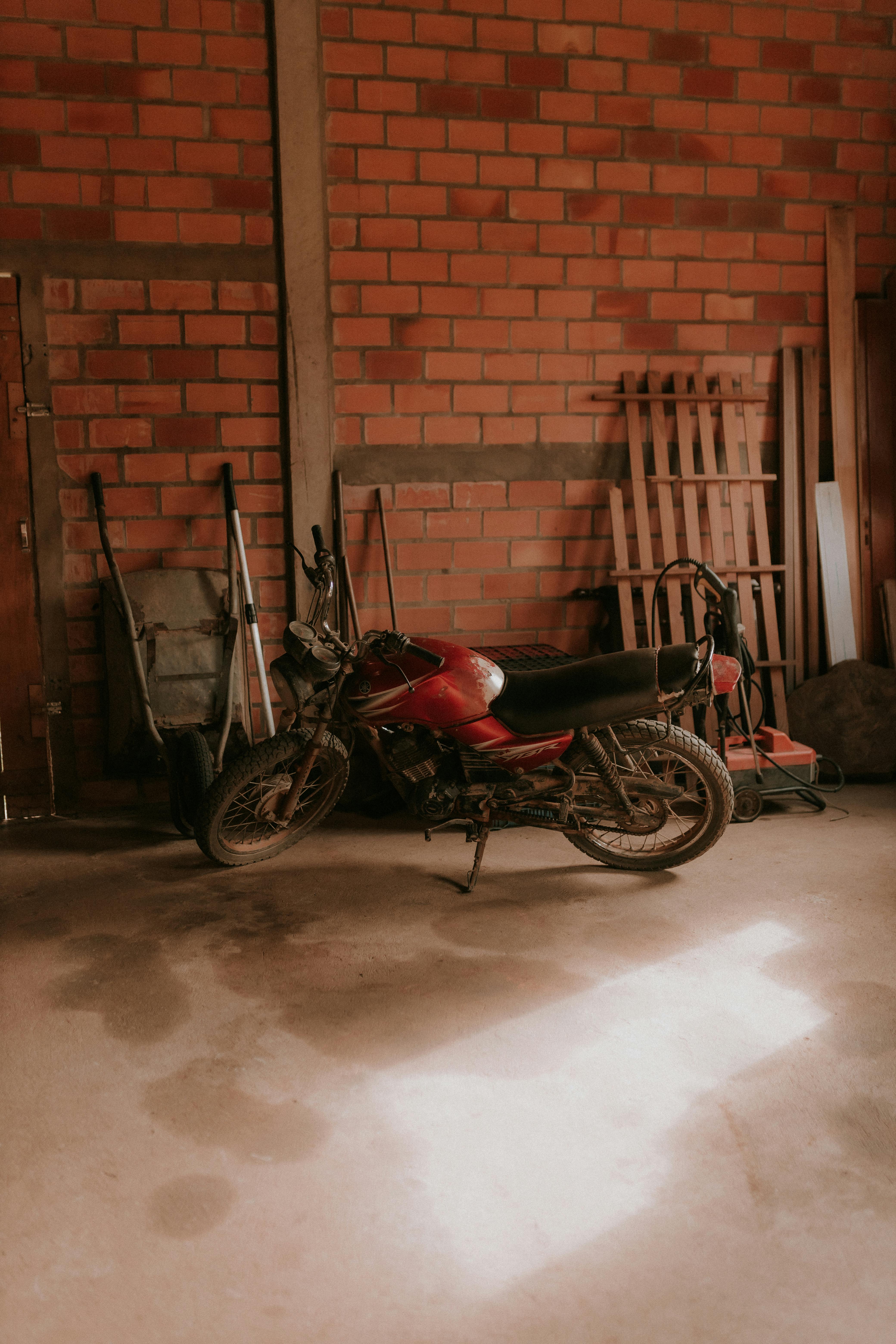 Vintage Motorcycle in Rustic Indoor Garage · Free Stock Photo