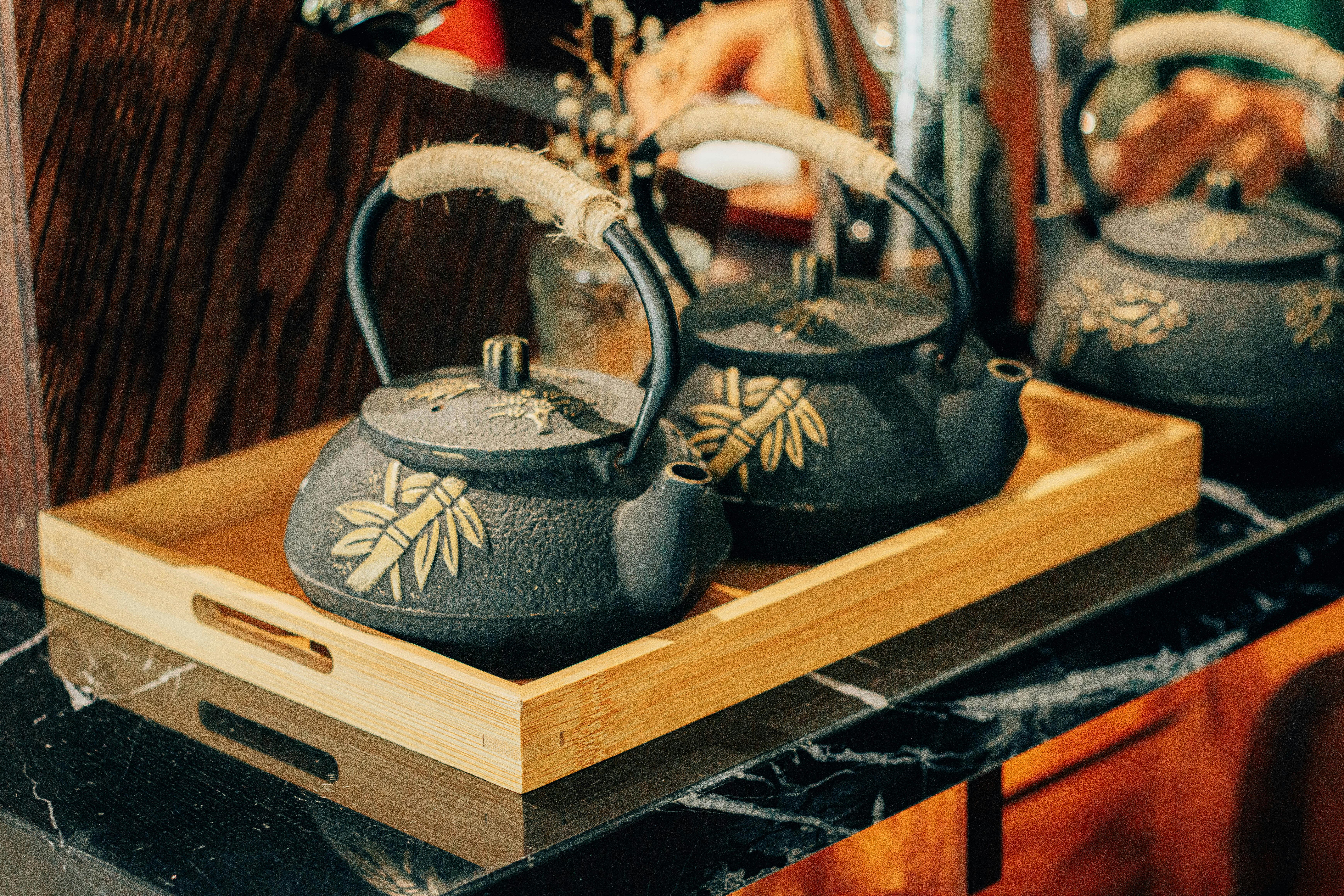 Traditional Cast Iron Teapots on Bamboo Tray · Free Stock Photo