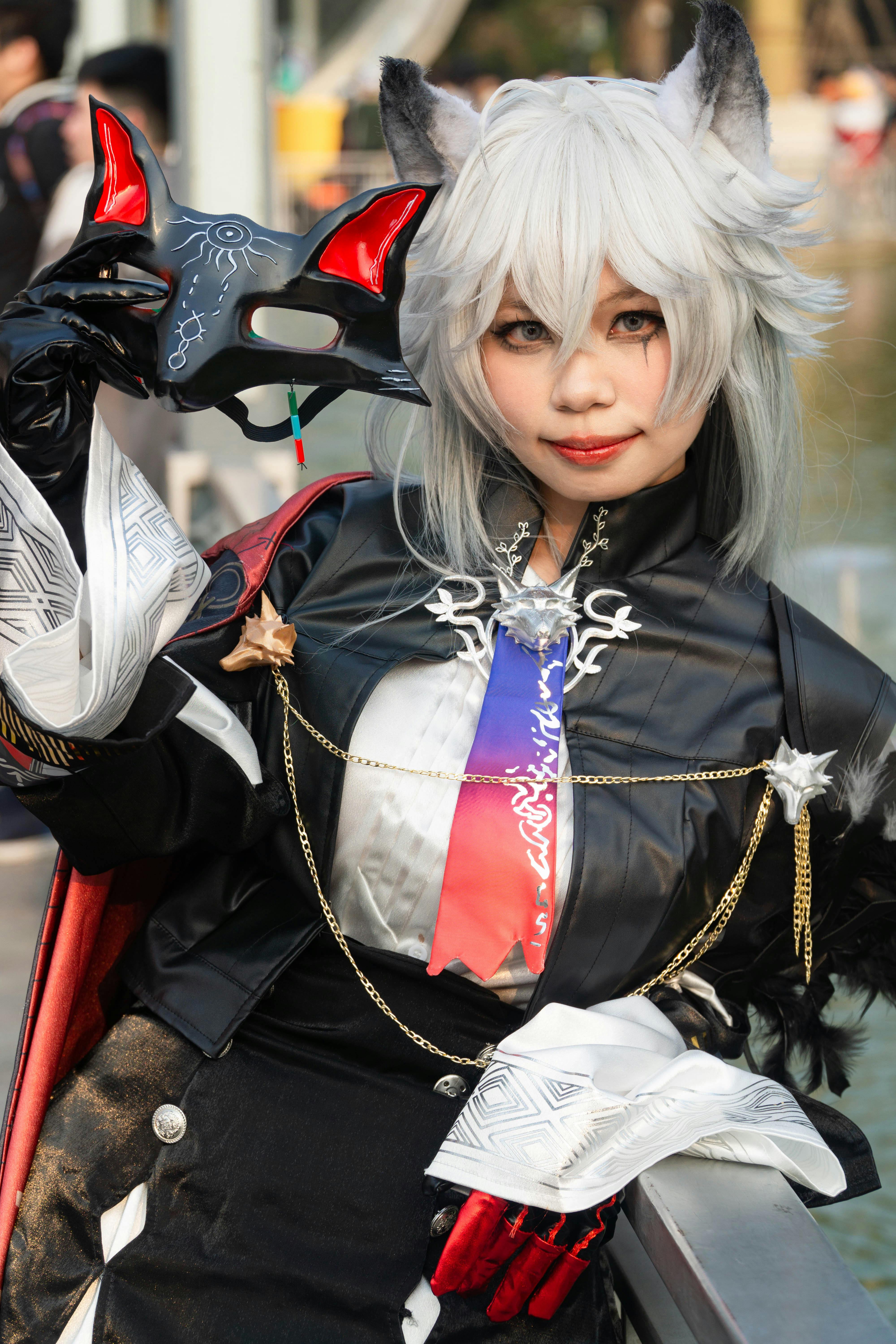 Cosplay Enthusiast Posing with Fox Mask Outdoors · Free Stock Photo