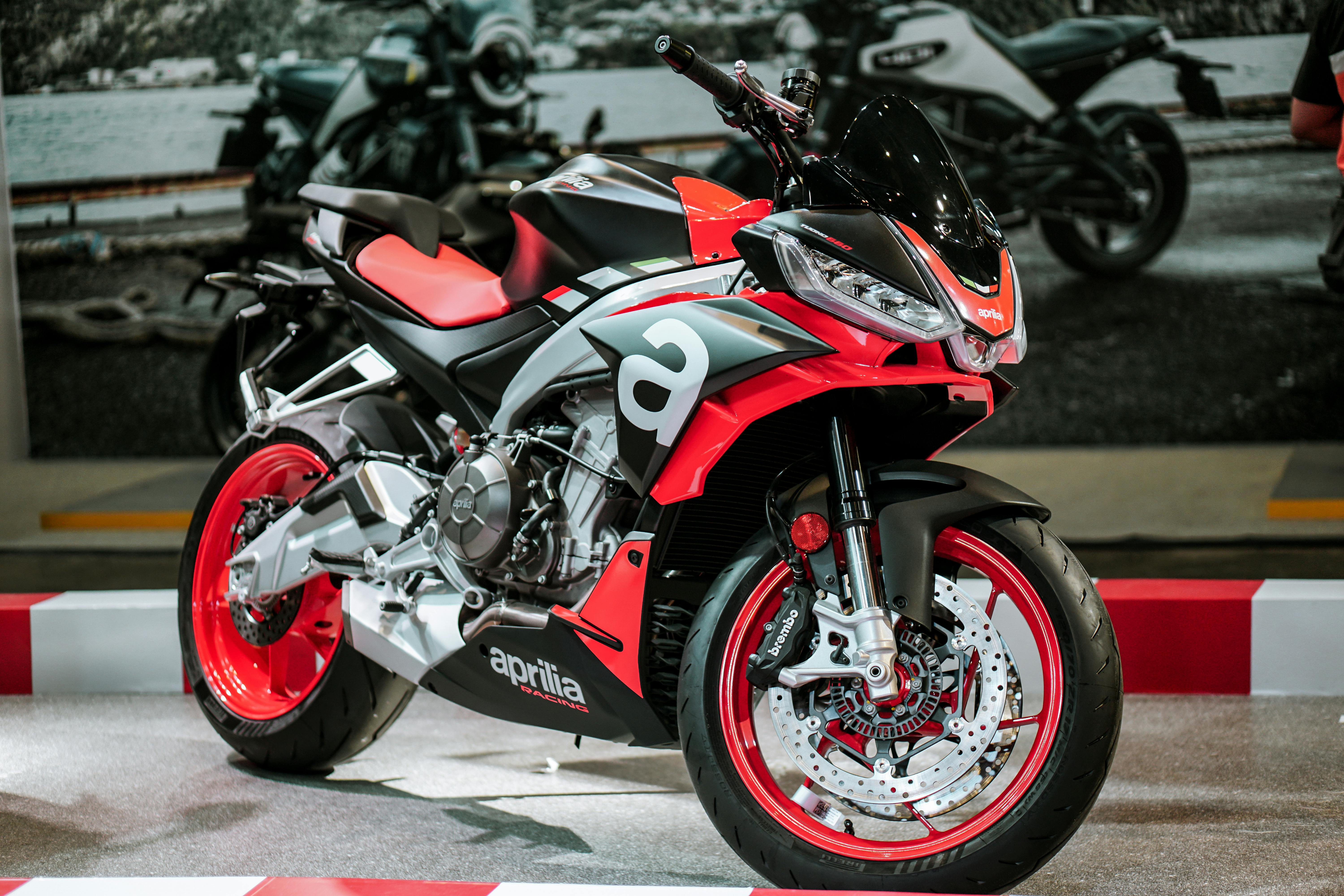Sleek Black and Red Aprilia Motorcycle on Display · Free Stock Photo