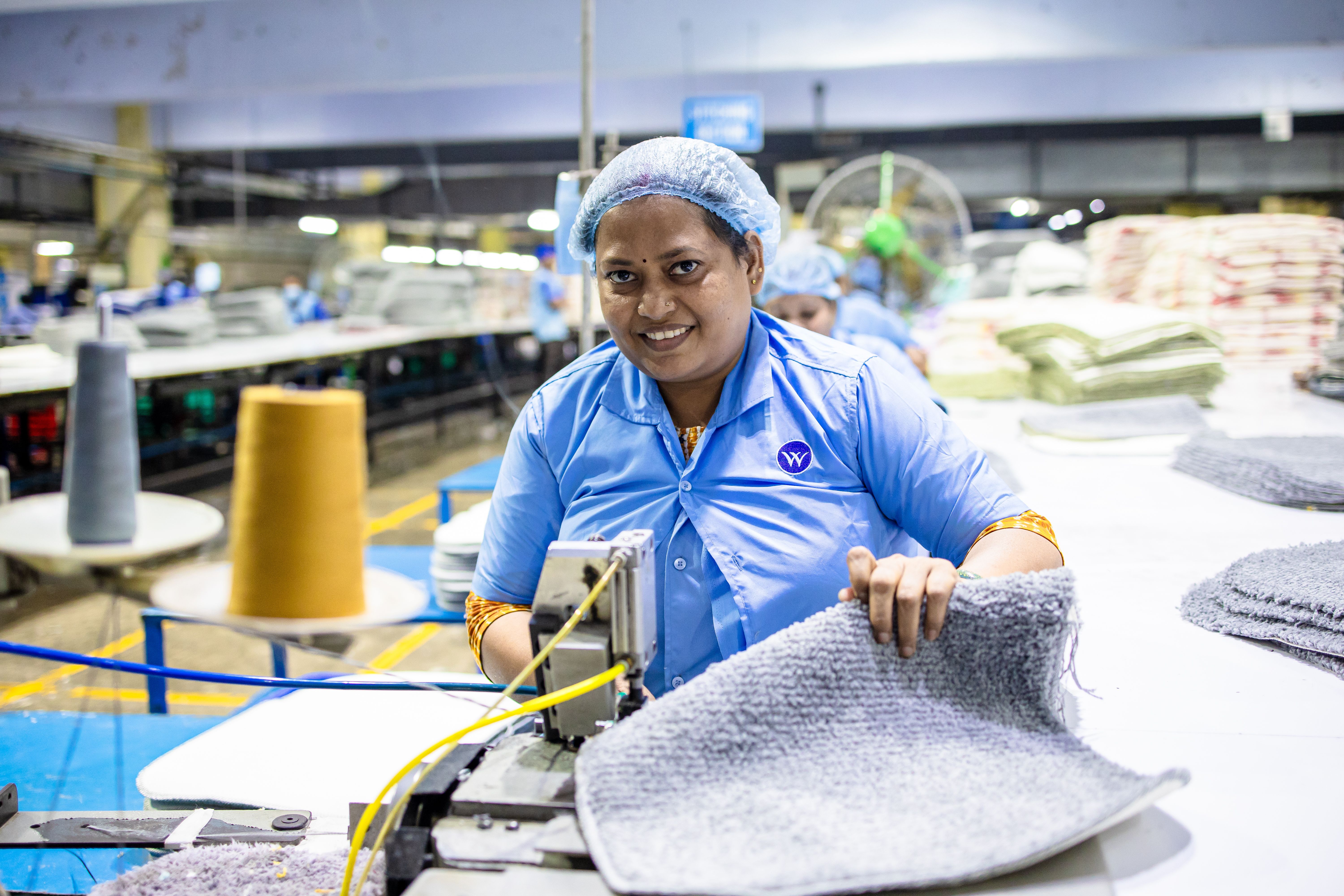 Smiling Textile Worker in Modern Factory · Free Stock Photo