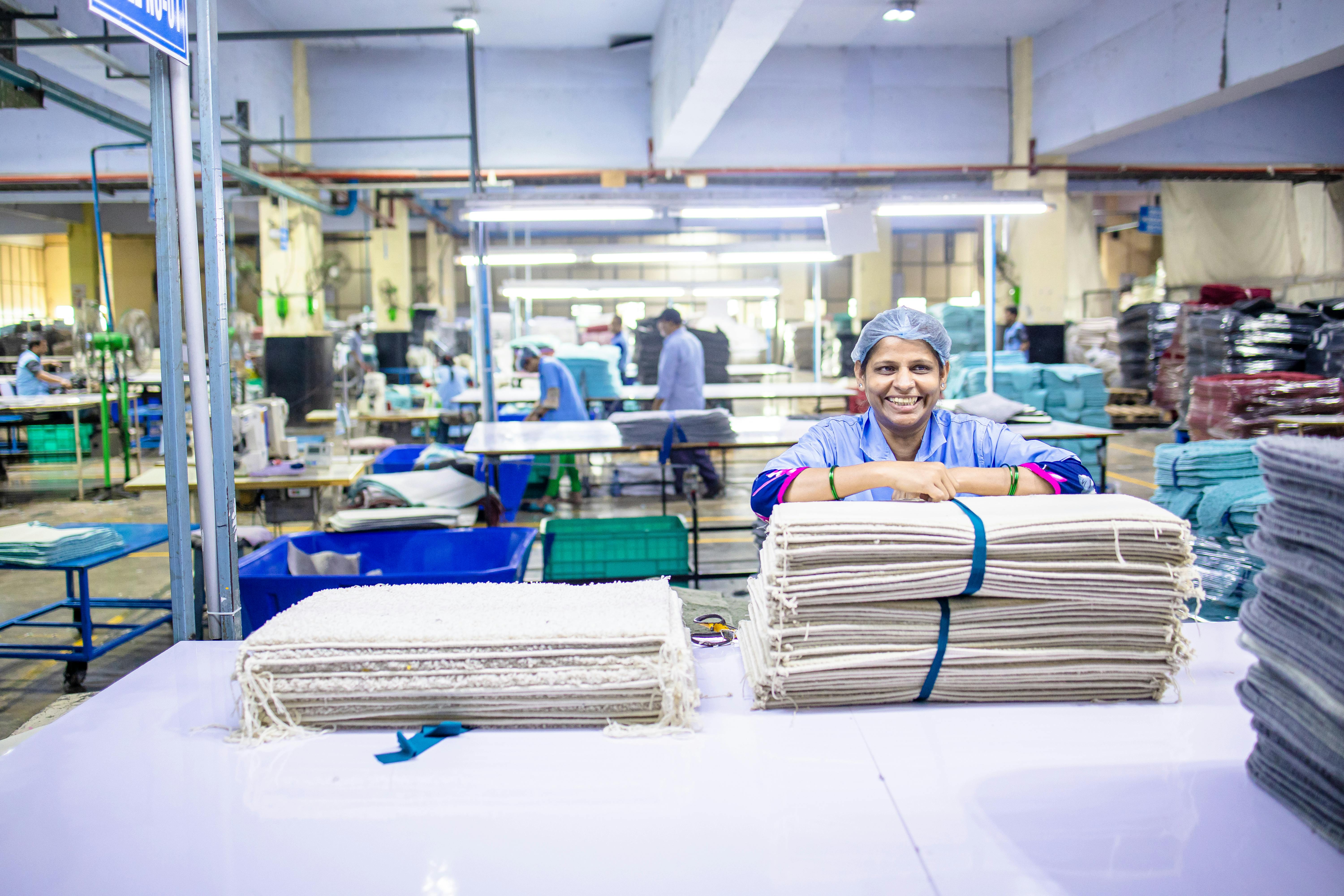 Smiling Factory Worker in Textile Industry · Free Stock Photo