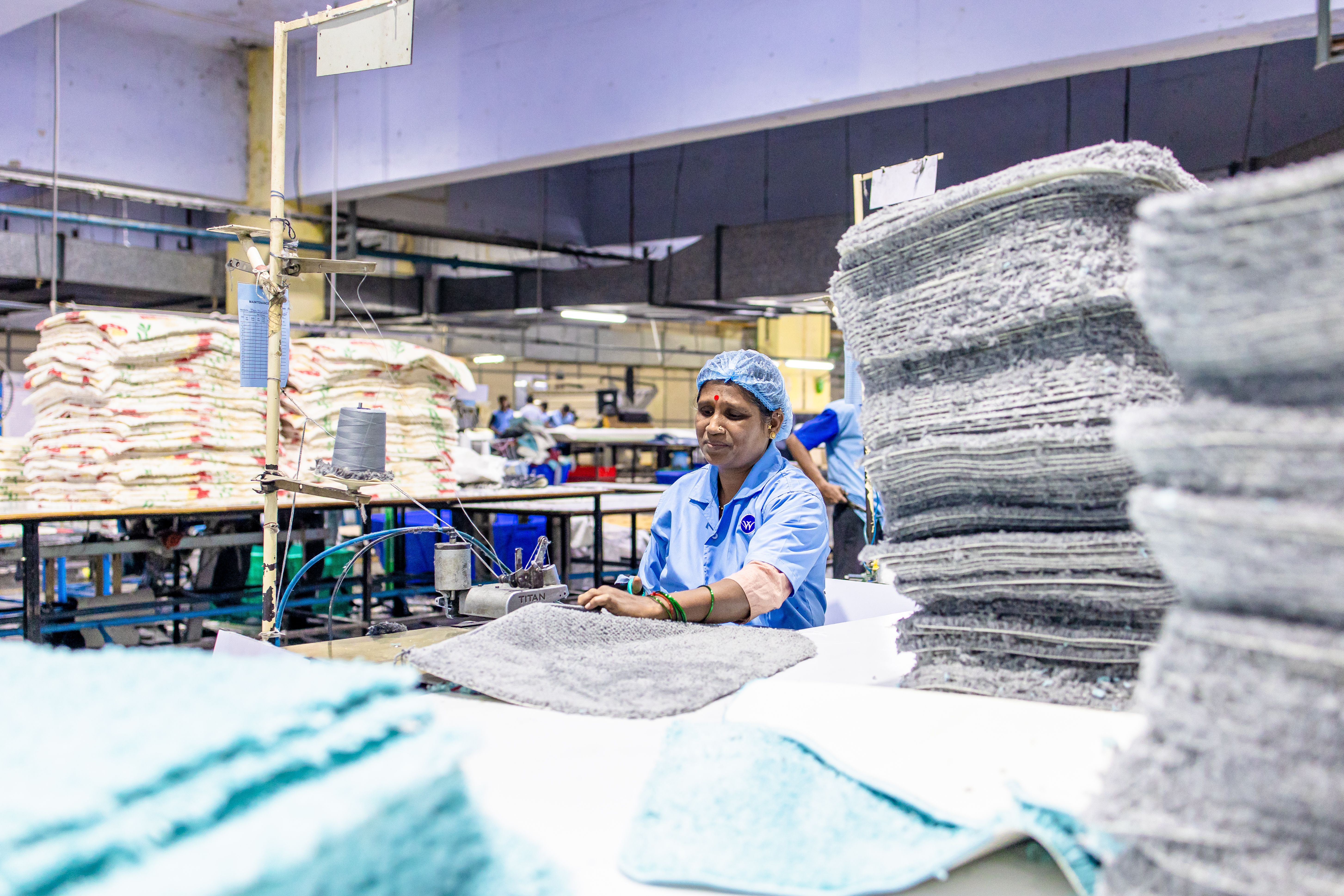 Textile Worker in Industrial Factory Setting · Free Stock Photo