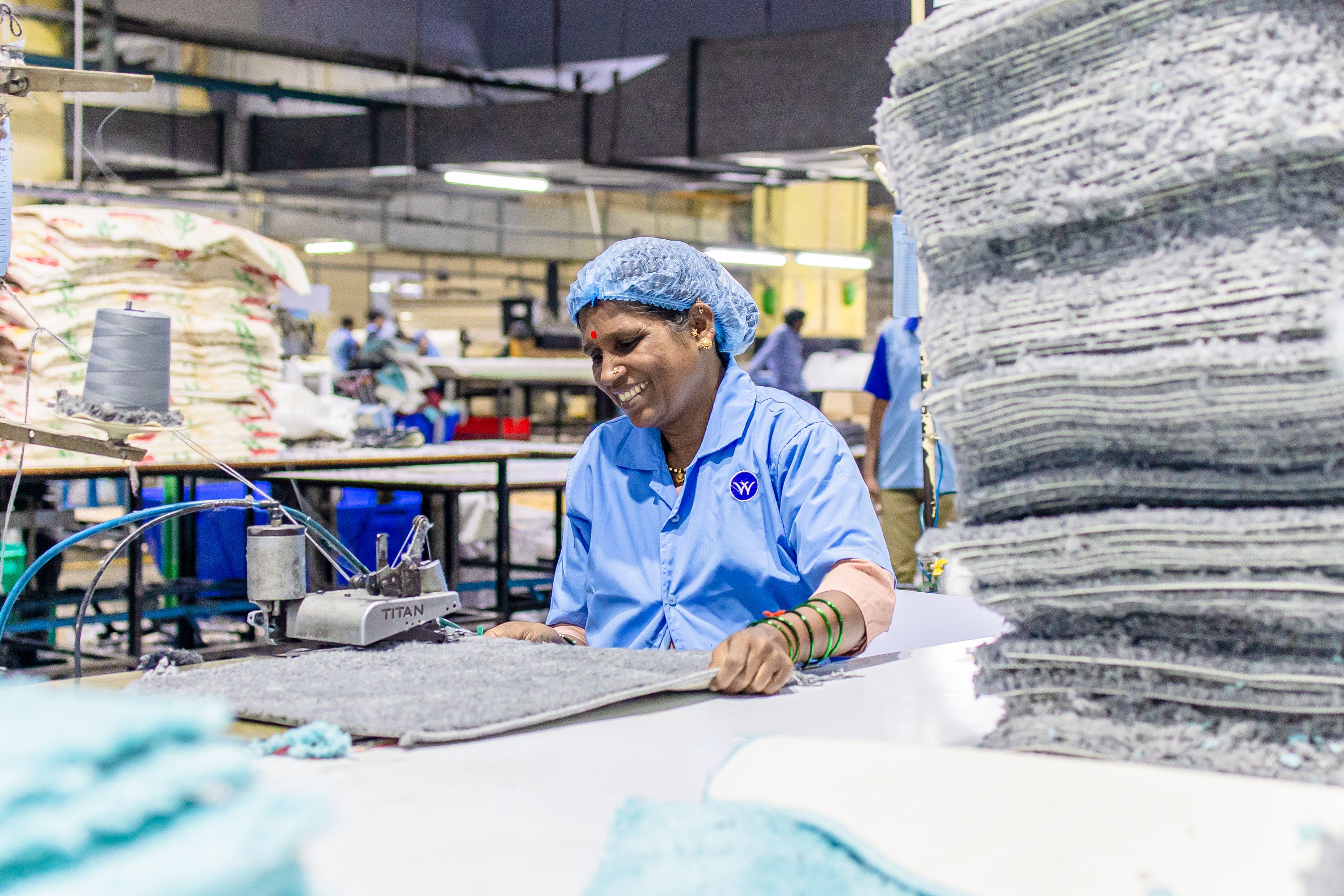 Smiling Textile Worker in Factory setting · Free Stock Photo