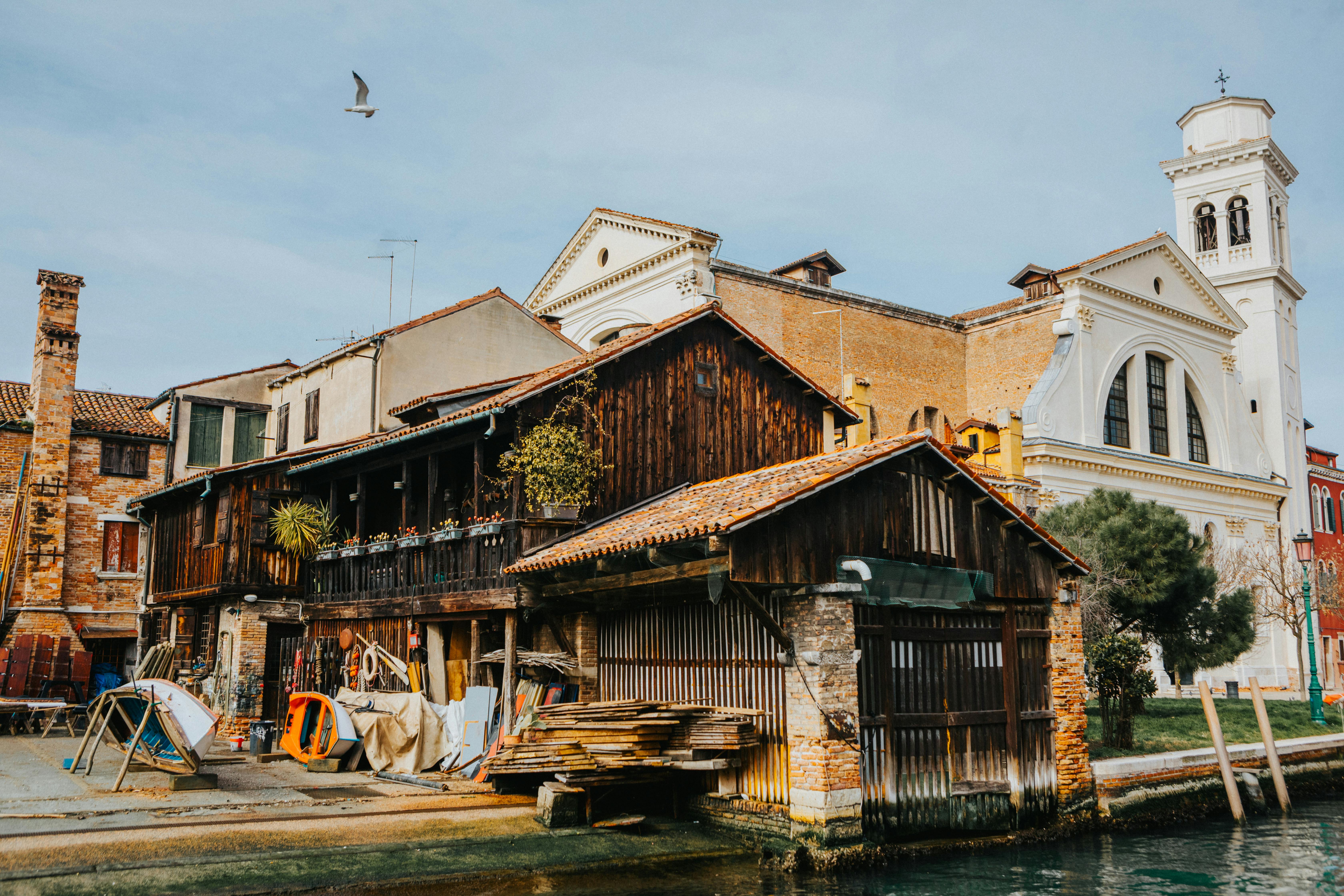 Rustic Boathouse and Church in Venice · Free Stock Photo