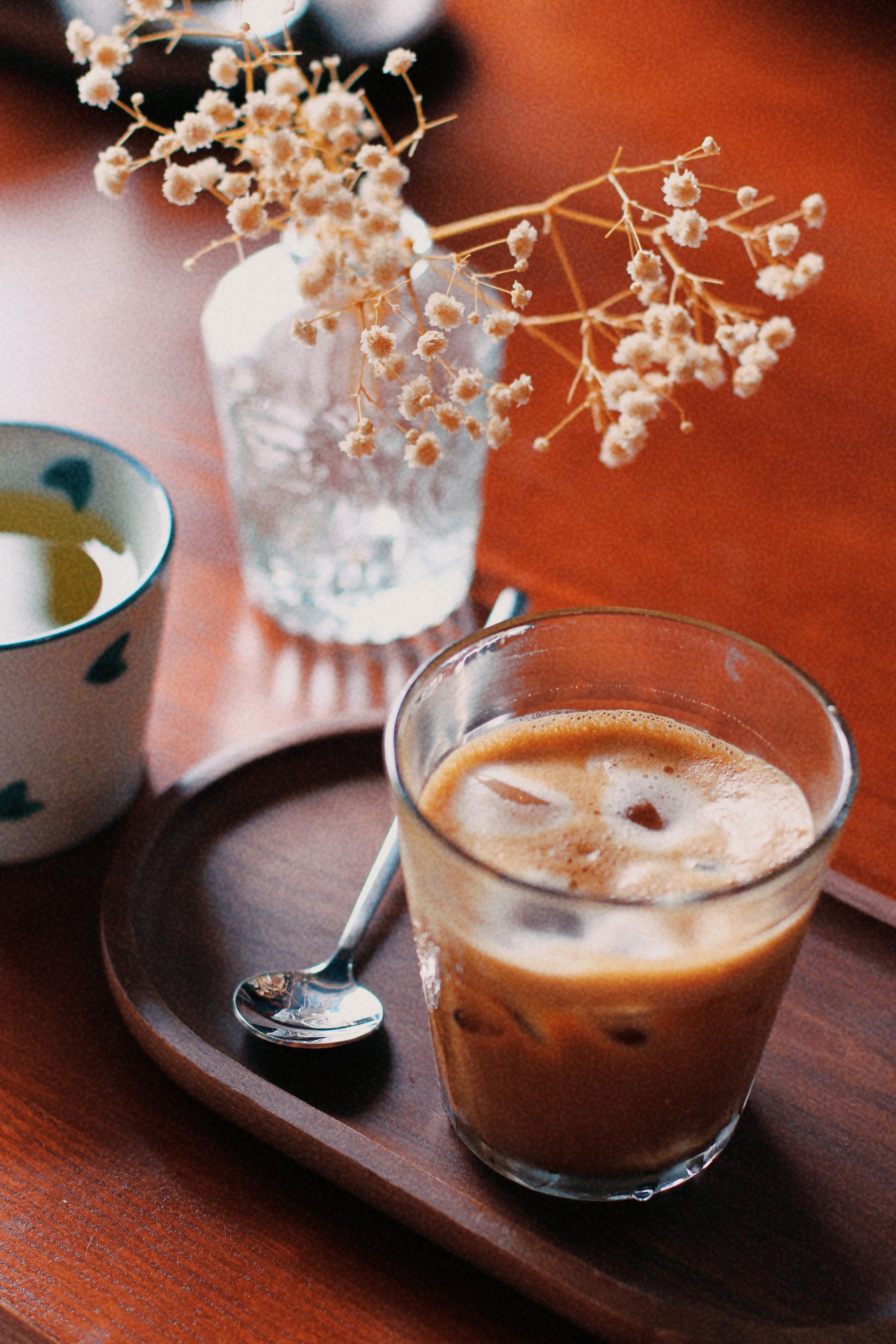 Cozy Coffee Setup with Iced Latte and Flowers · Free Stock Photo