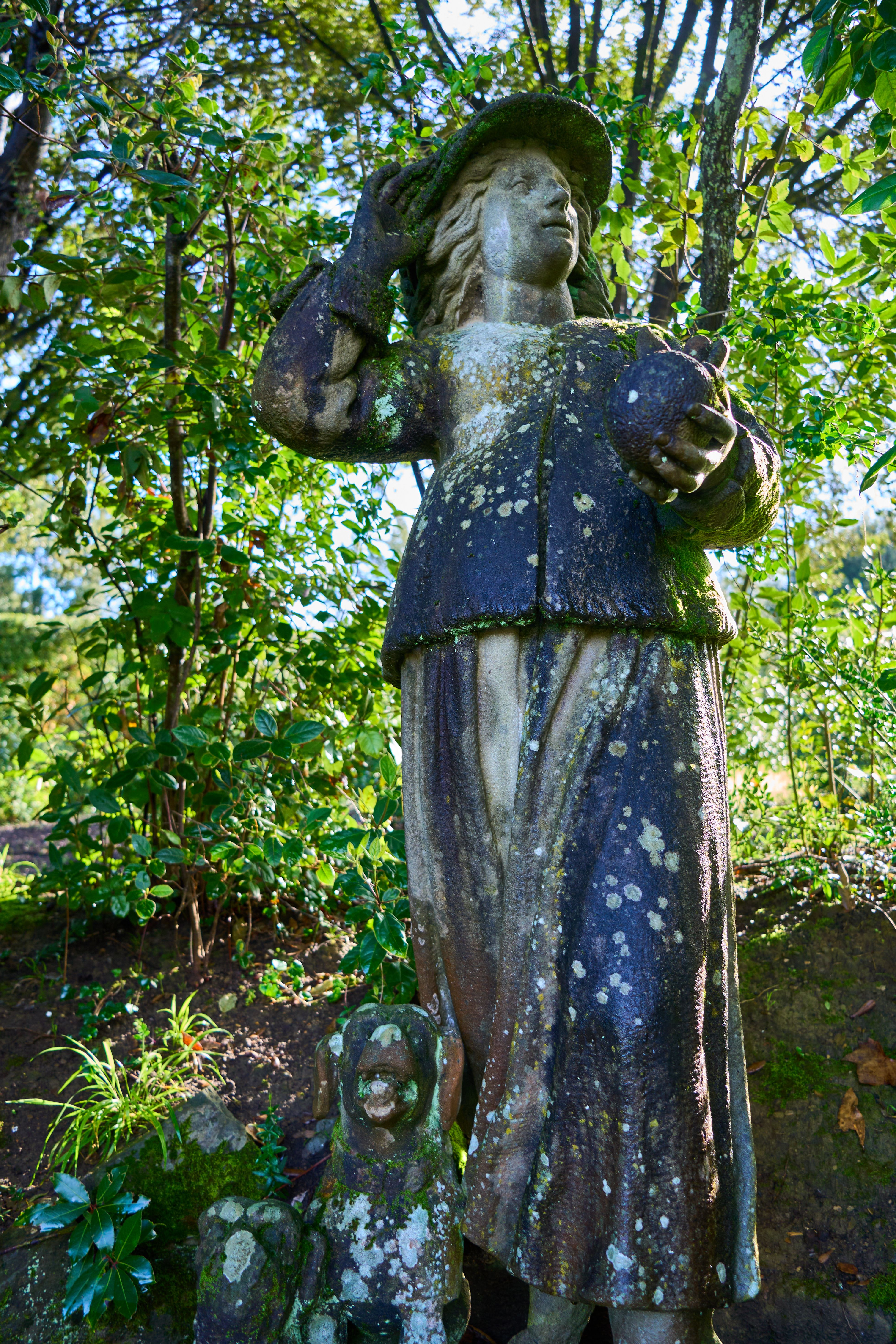 Stone Statue of Woman in Lush Garden Setting · Free Stock Photo