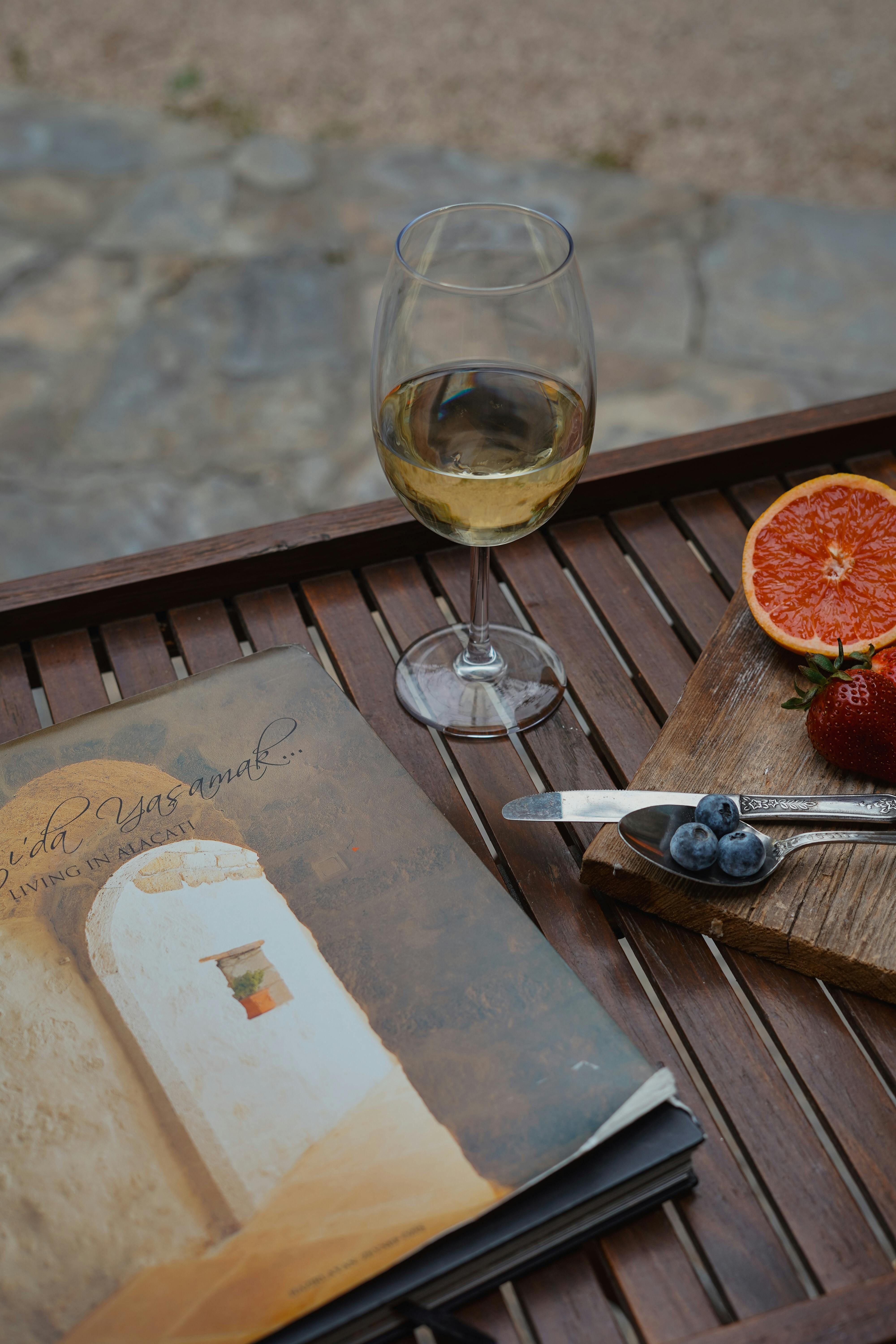 Relaxing Outdoor Wine and Fruit Setup on Wooden Table · Free Stock Photo
