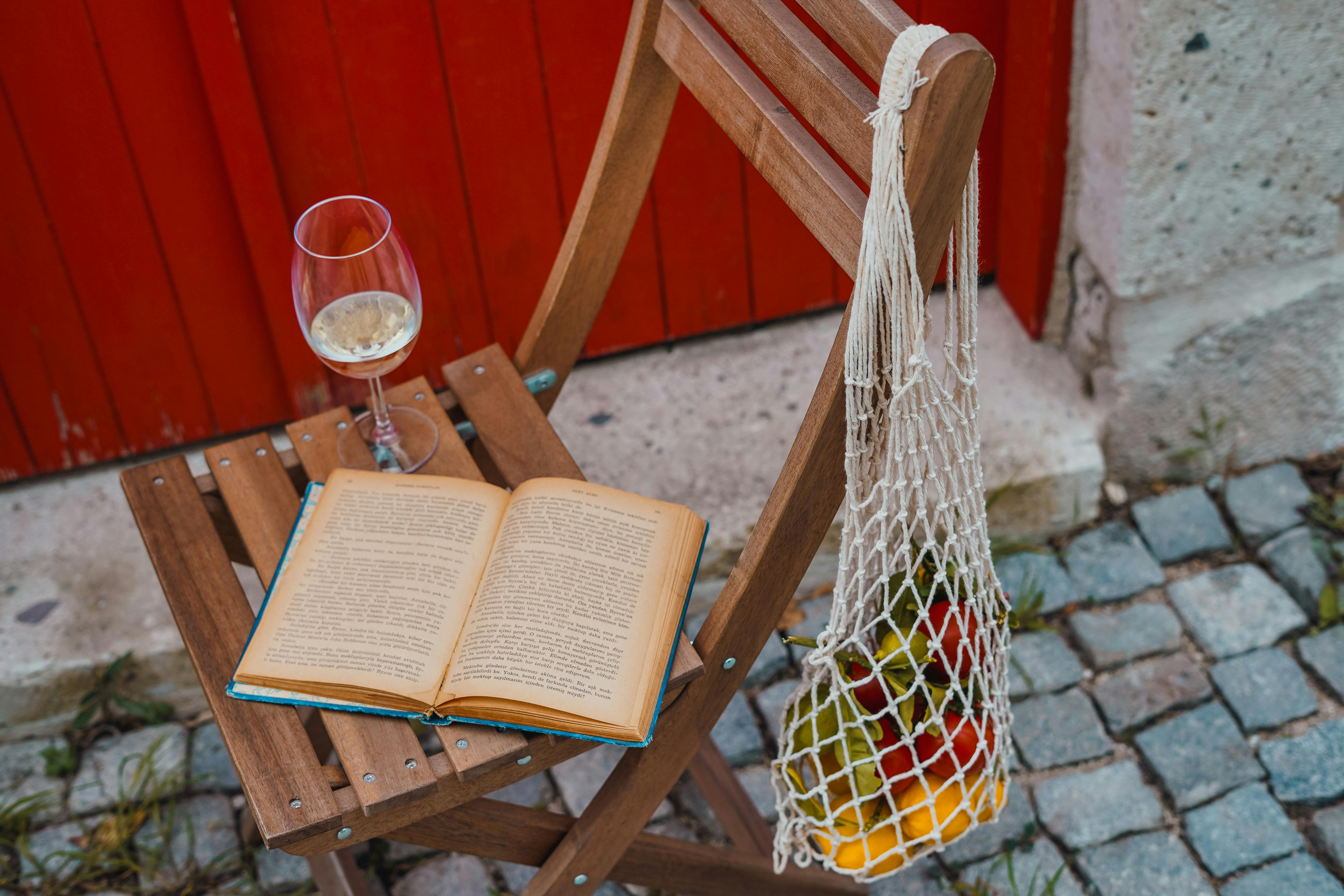 Rustic Setup with Wine, Book, and Fruit Outdoors · Free Stock Photo
