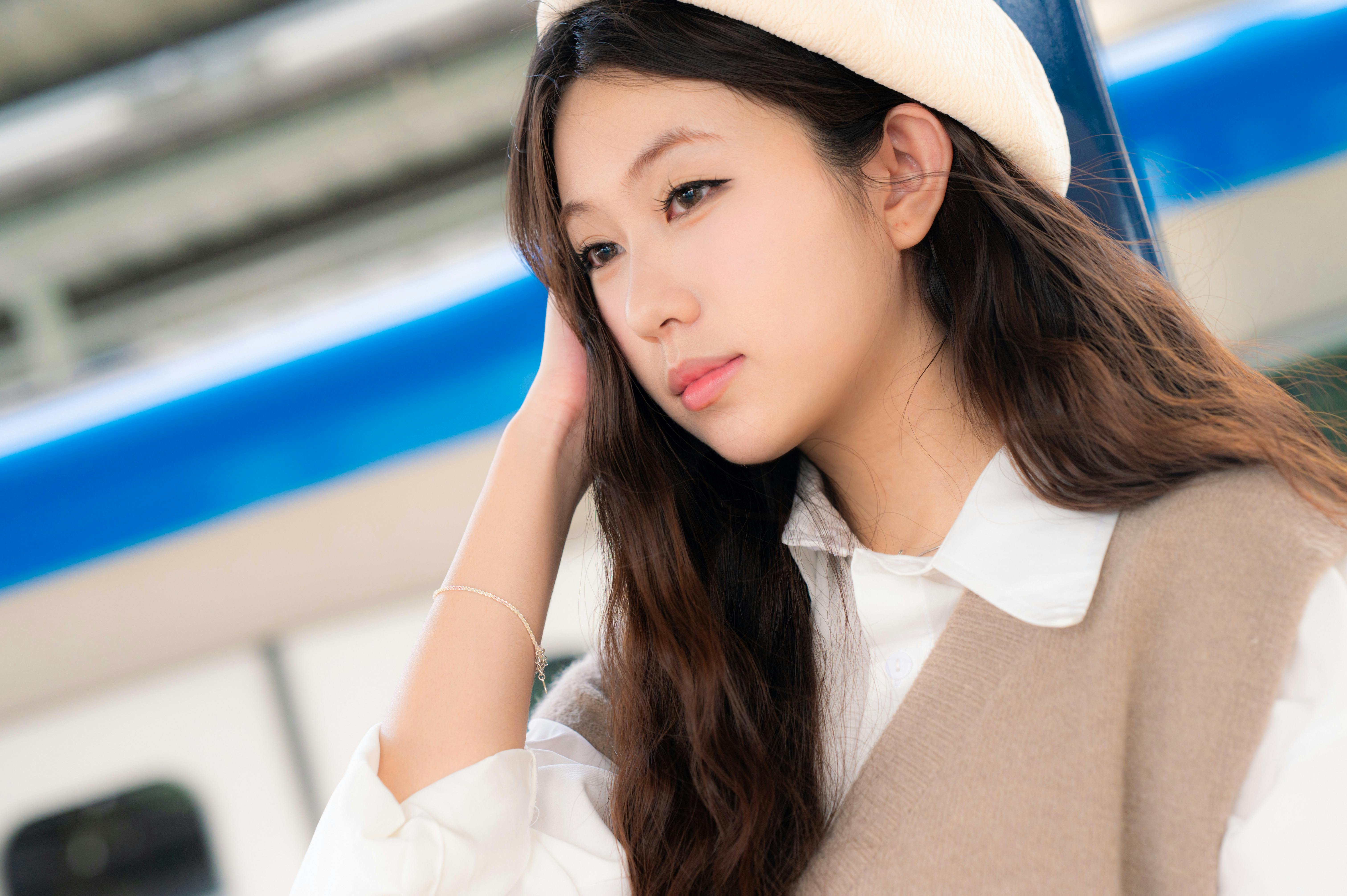 Fashionable Young Woman in Beret at Train Station · Free Stock Photo