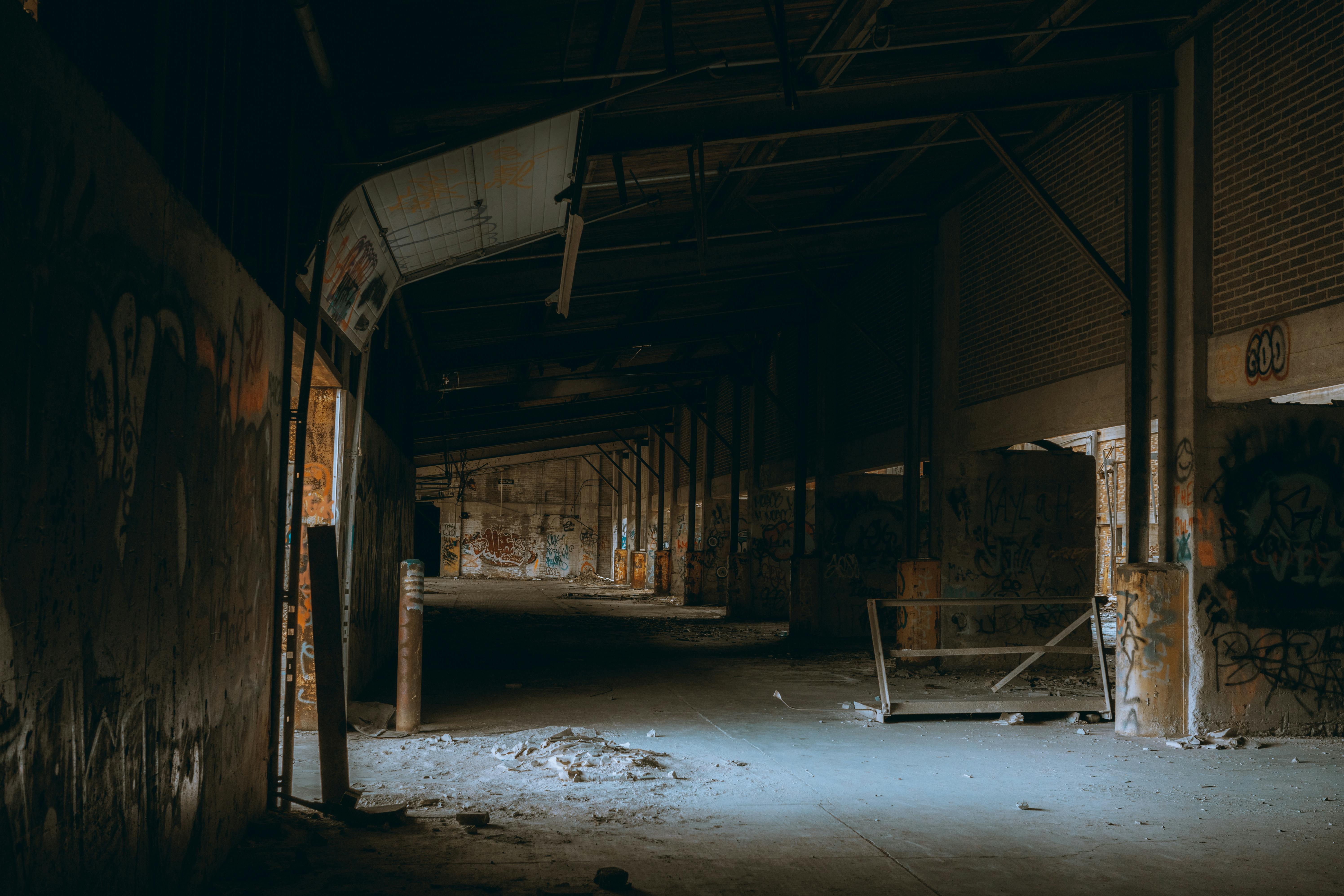Dark Abandoned Warehouse with Graffiti Art · Free Stock Photo