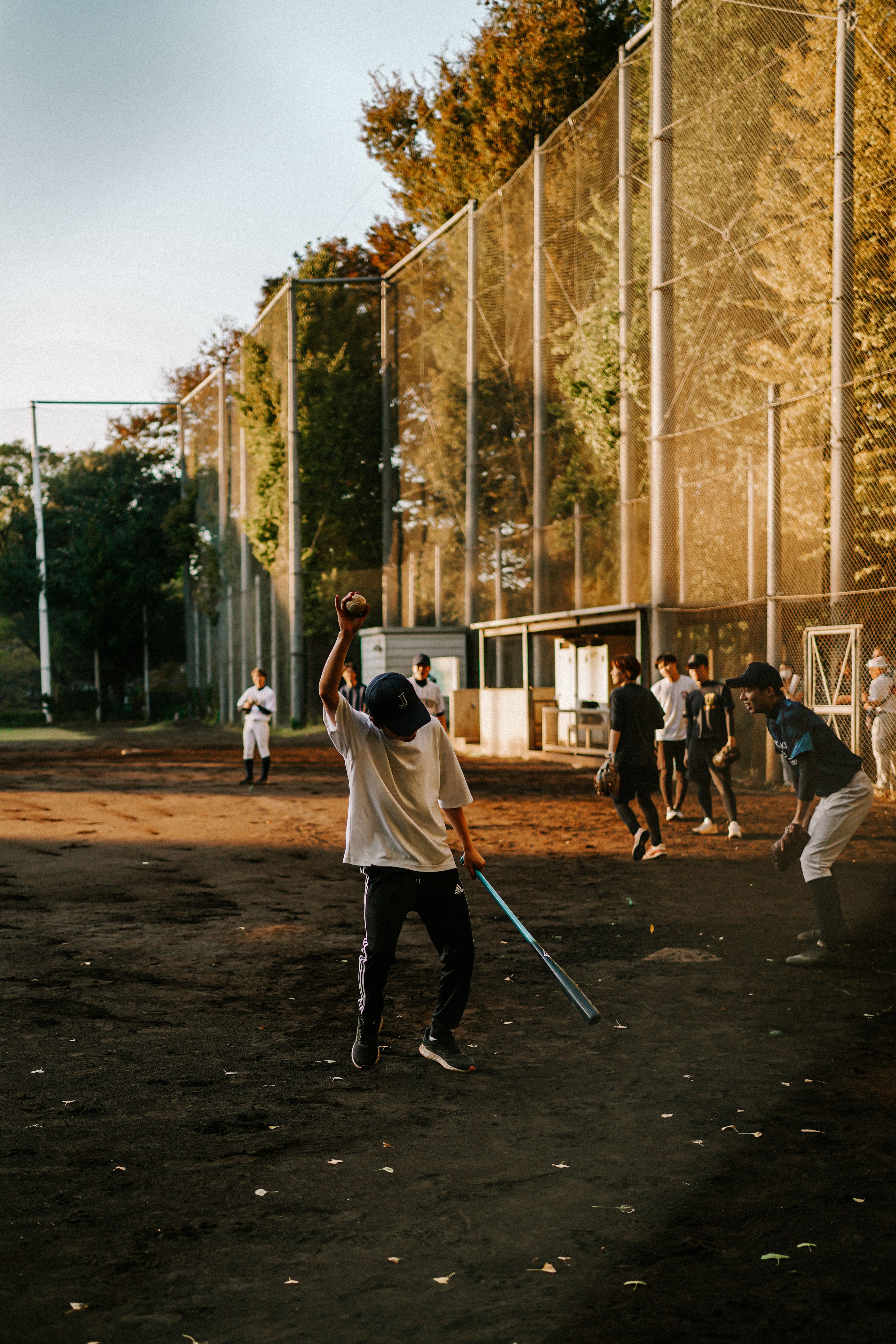 Youth playing baseball game in sunny Japan · Free Stock Photo