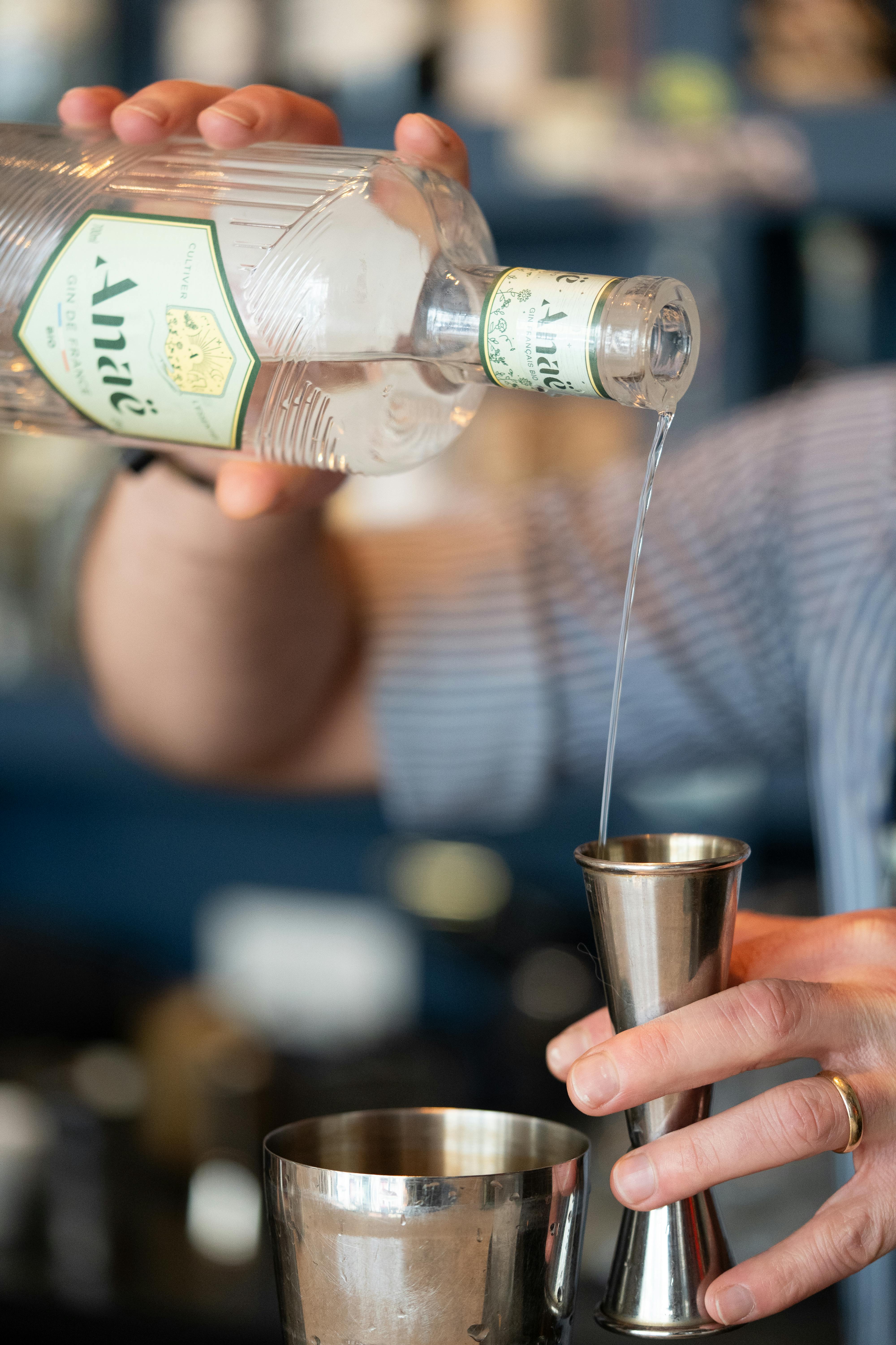 Bartender Pouring Gin into Jigger at Paris Bar · Free Stock Photo