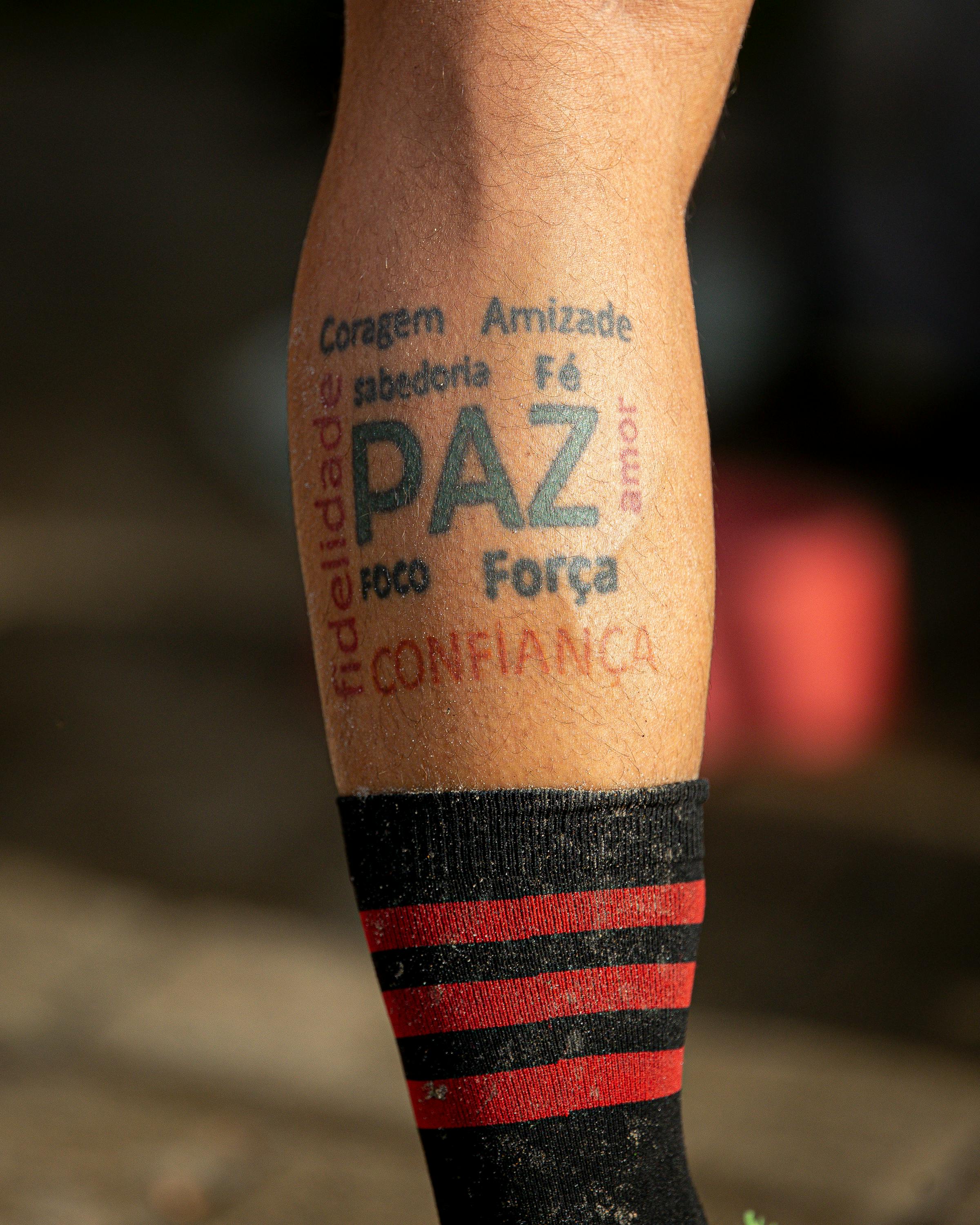 Close-up of Tattooed Words on Leg Highlighting Peace · Free Stock Photo