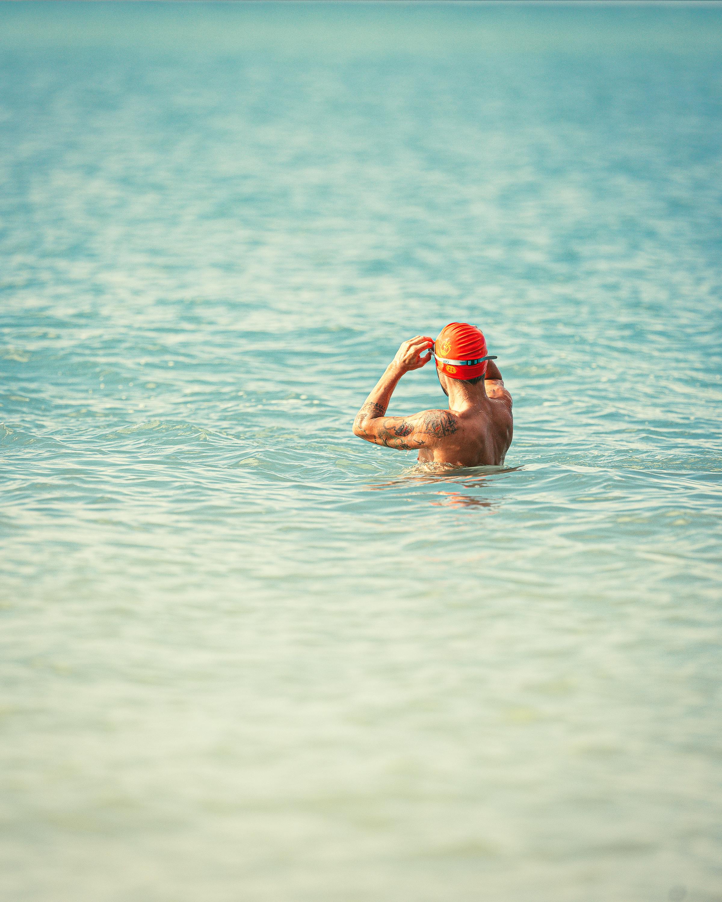Man Swimming Solo in Calm Ocean Waters · Free Stock Photo