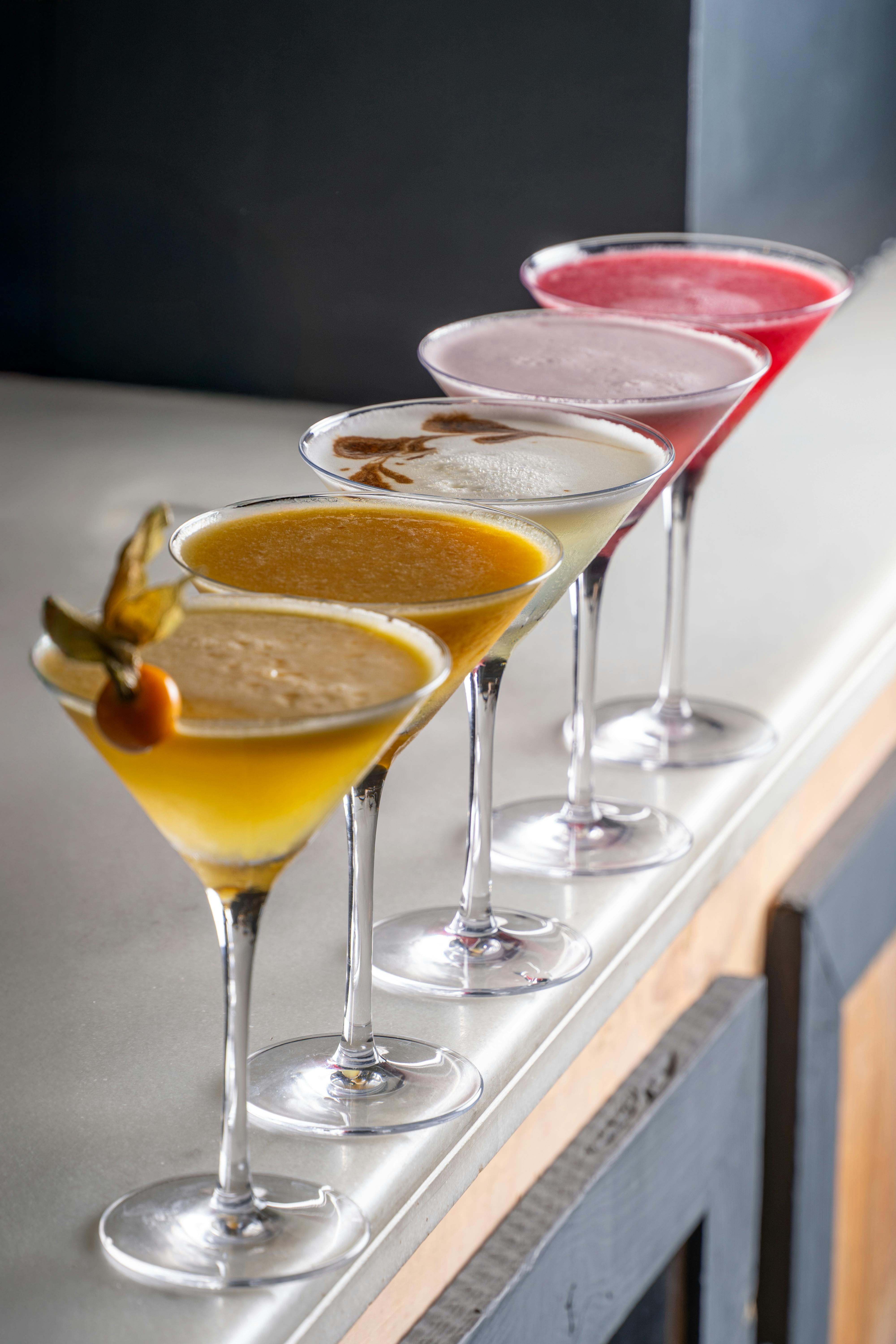 Vibrant Cocktail Variety on Sleek Bar Counter · Free Stock Photo