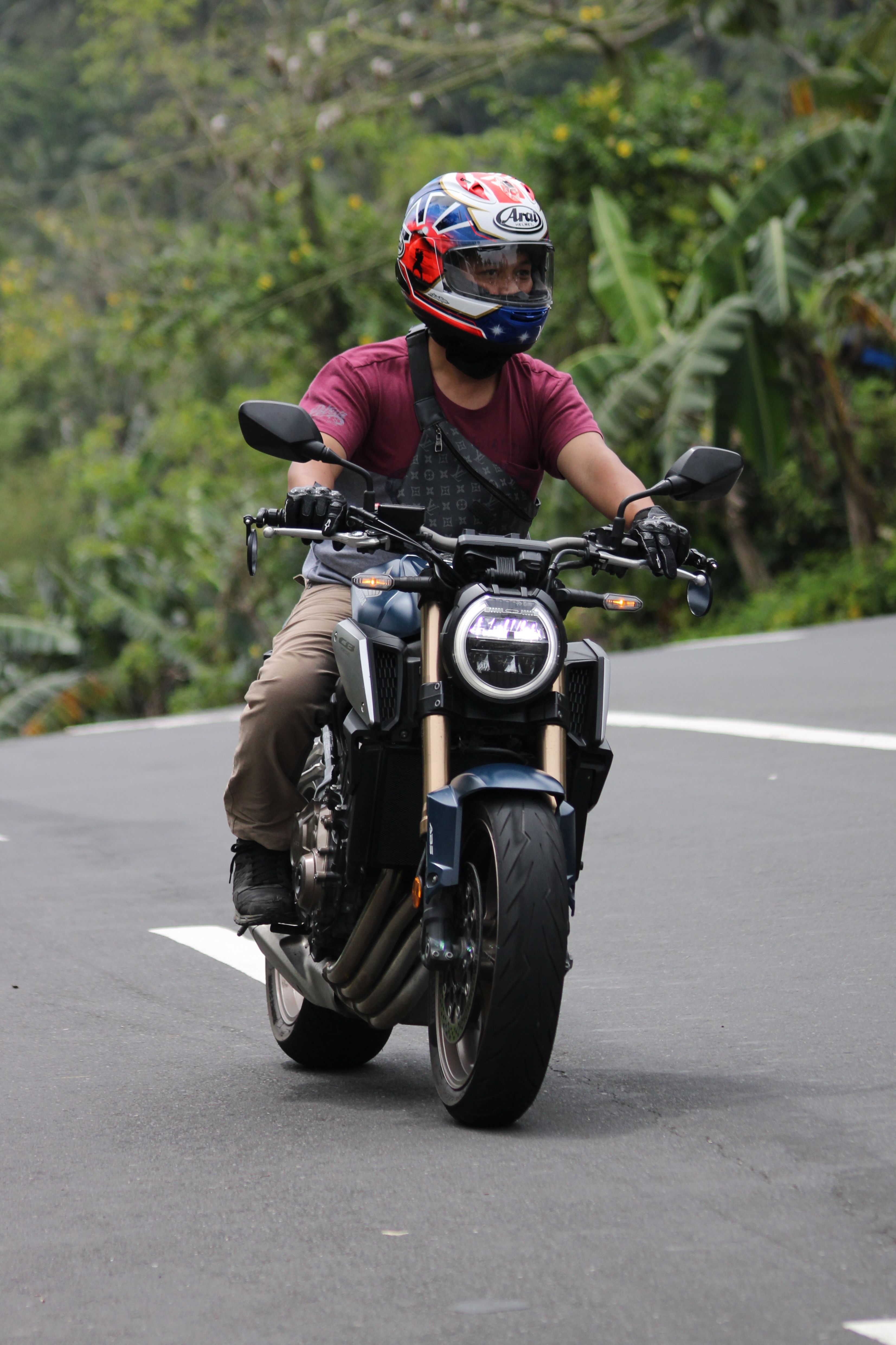 Motorcyclist Riding on Urban Roadway · Free Stock Photo