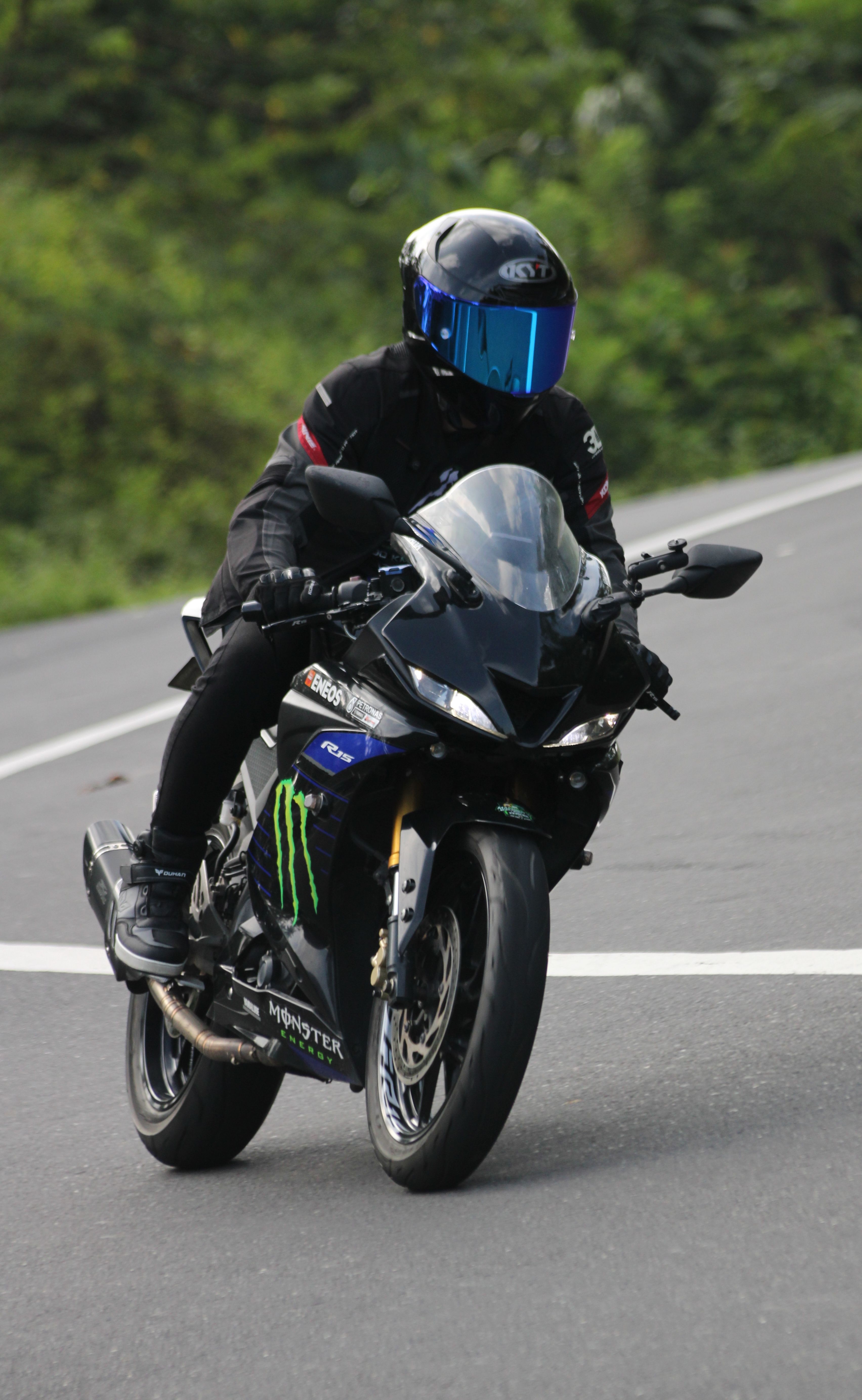 Motorcyclist Riding Sportbike on Winding Road · Free Stock Photo