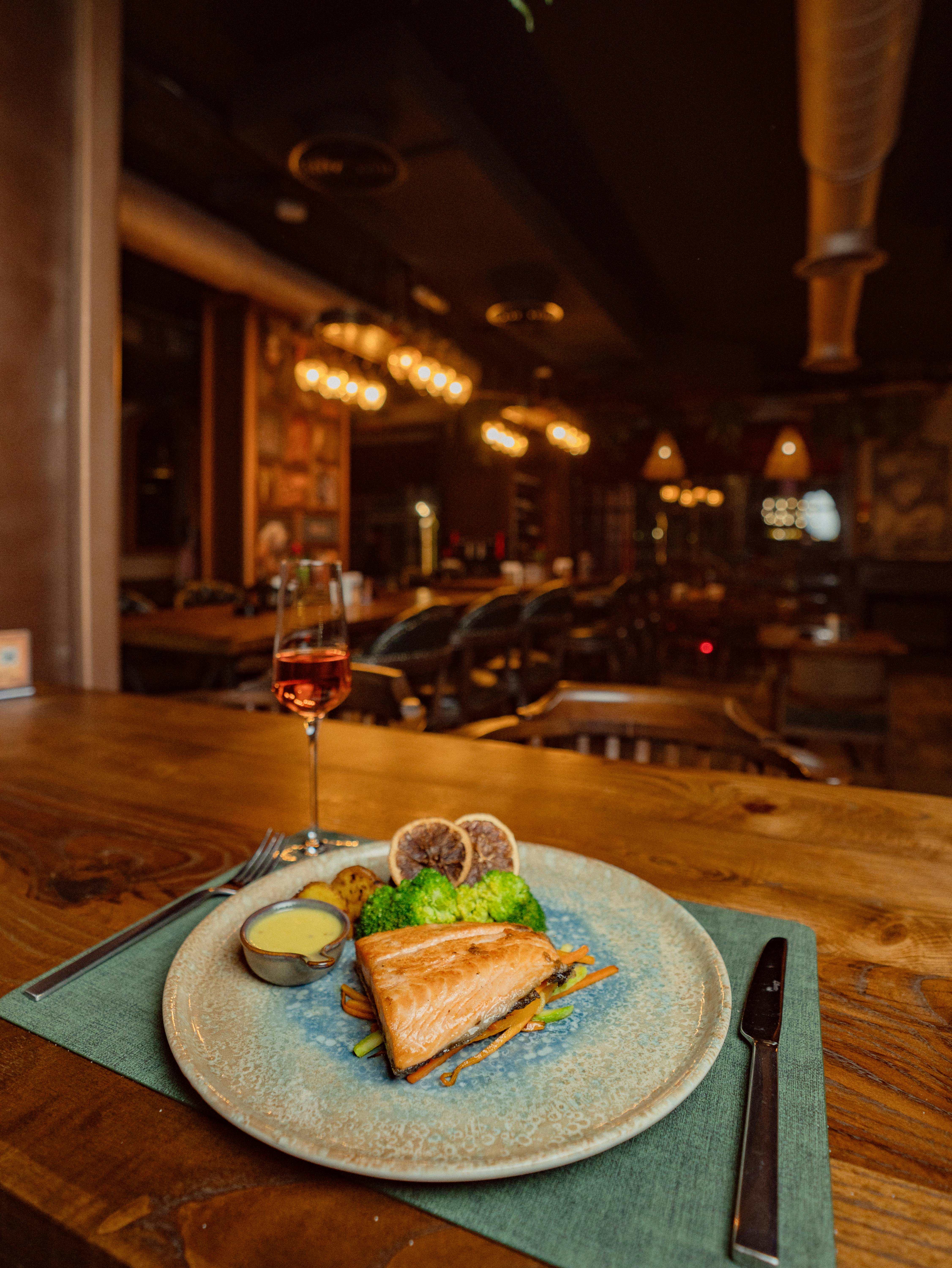 Gourmet Salmon Dish in Ambient Iraqi Restaurant · Free Stock Photo