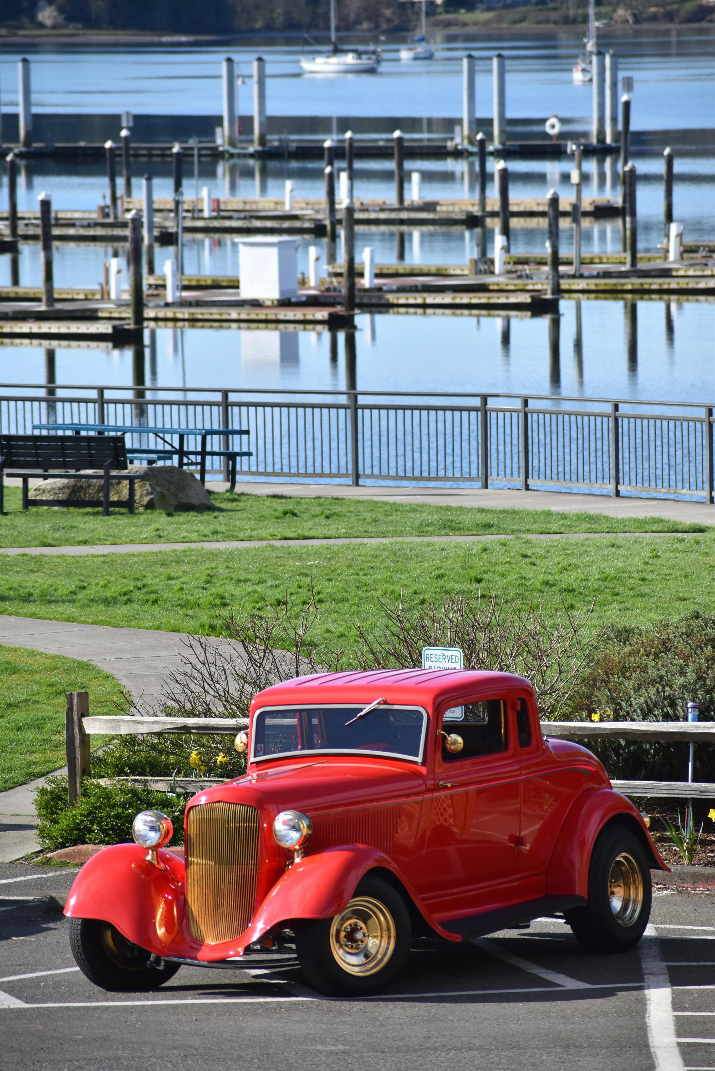 Vintage Red Car by Serene Waterfront Docks · Free Stock Photo