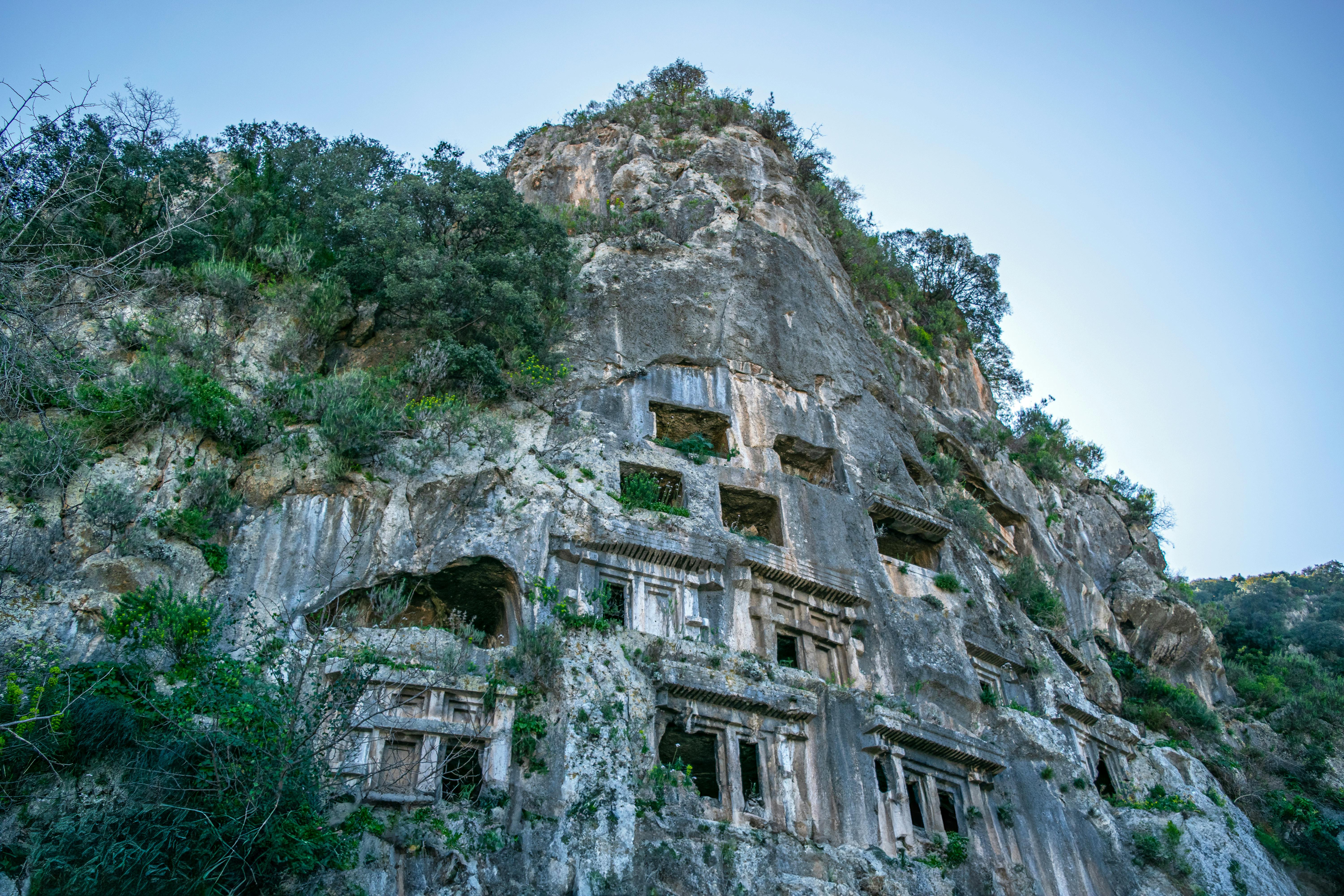Ancient Rock-Cut Tombs in Mountain Cliff · Free Stock Photo