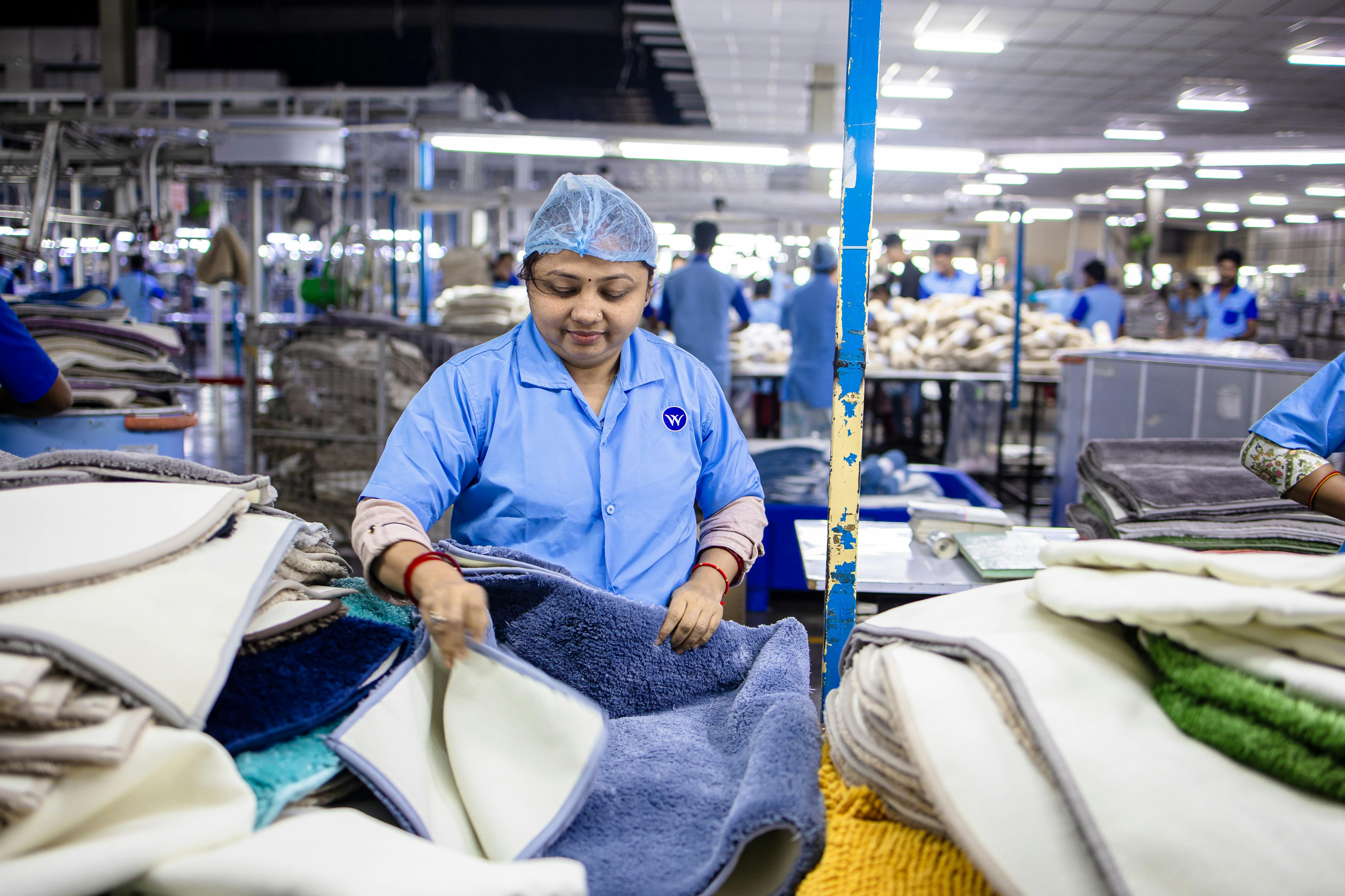 Female Worker in Textile Factory Sorting Fabrics · Free Stock Photo