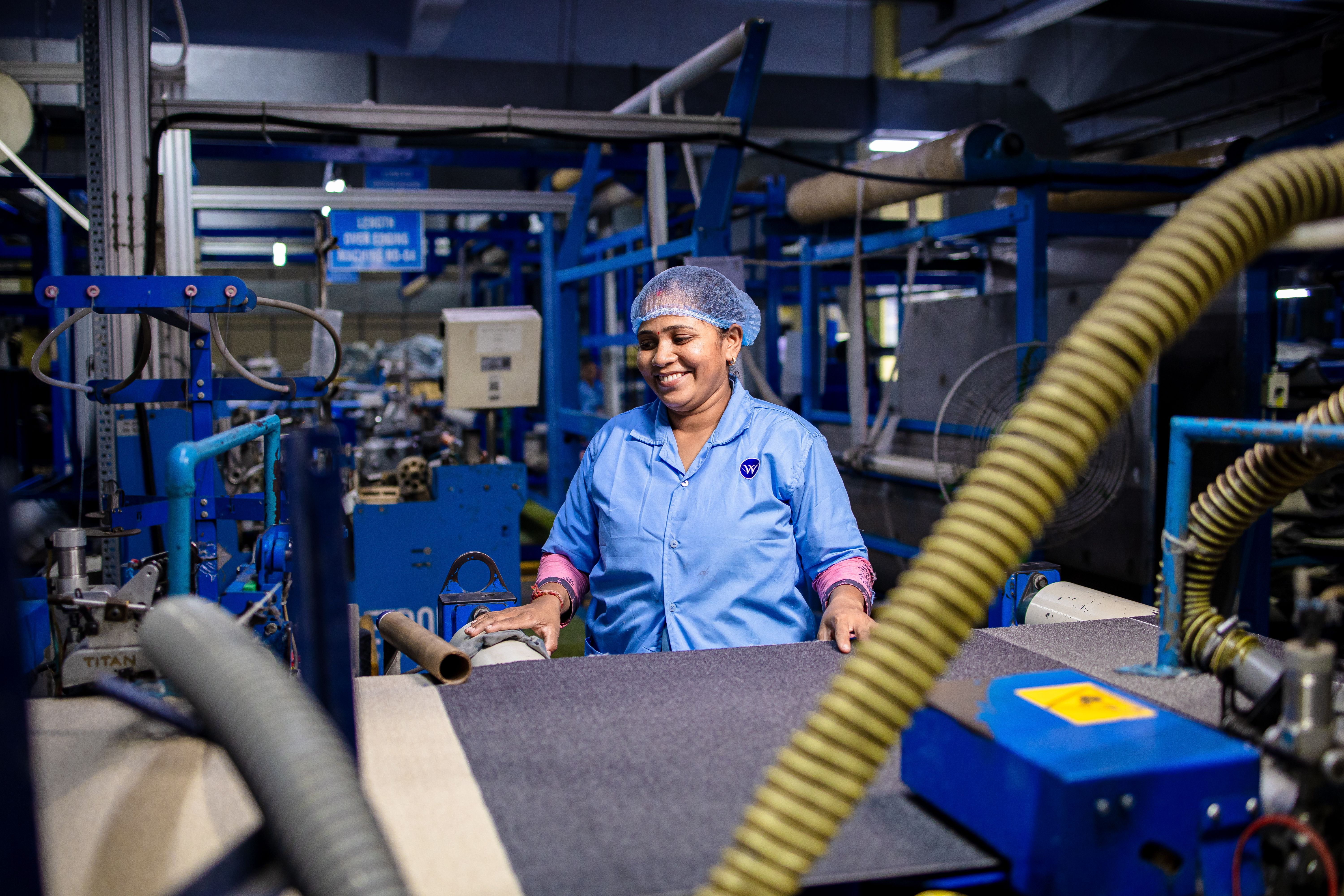 Smiling Female Worker in Textile Factory · Free Stock Photo