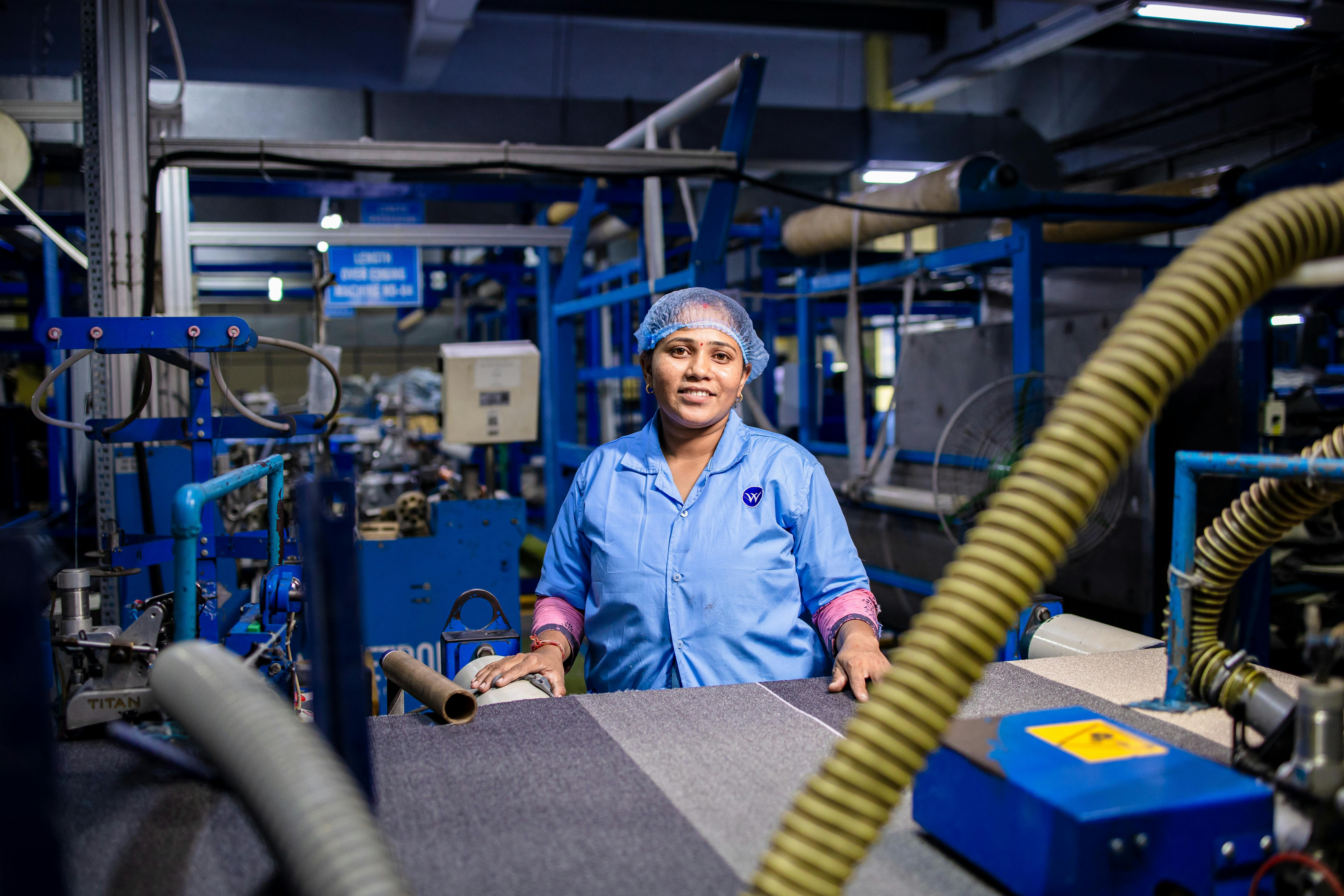 Female Textile Worker in Factory Setting · Free Stock Photo