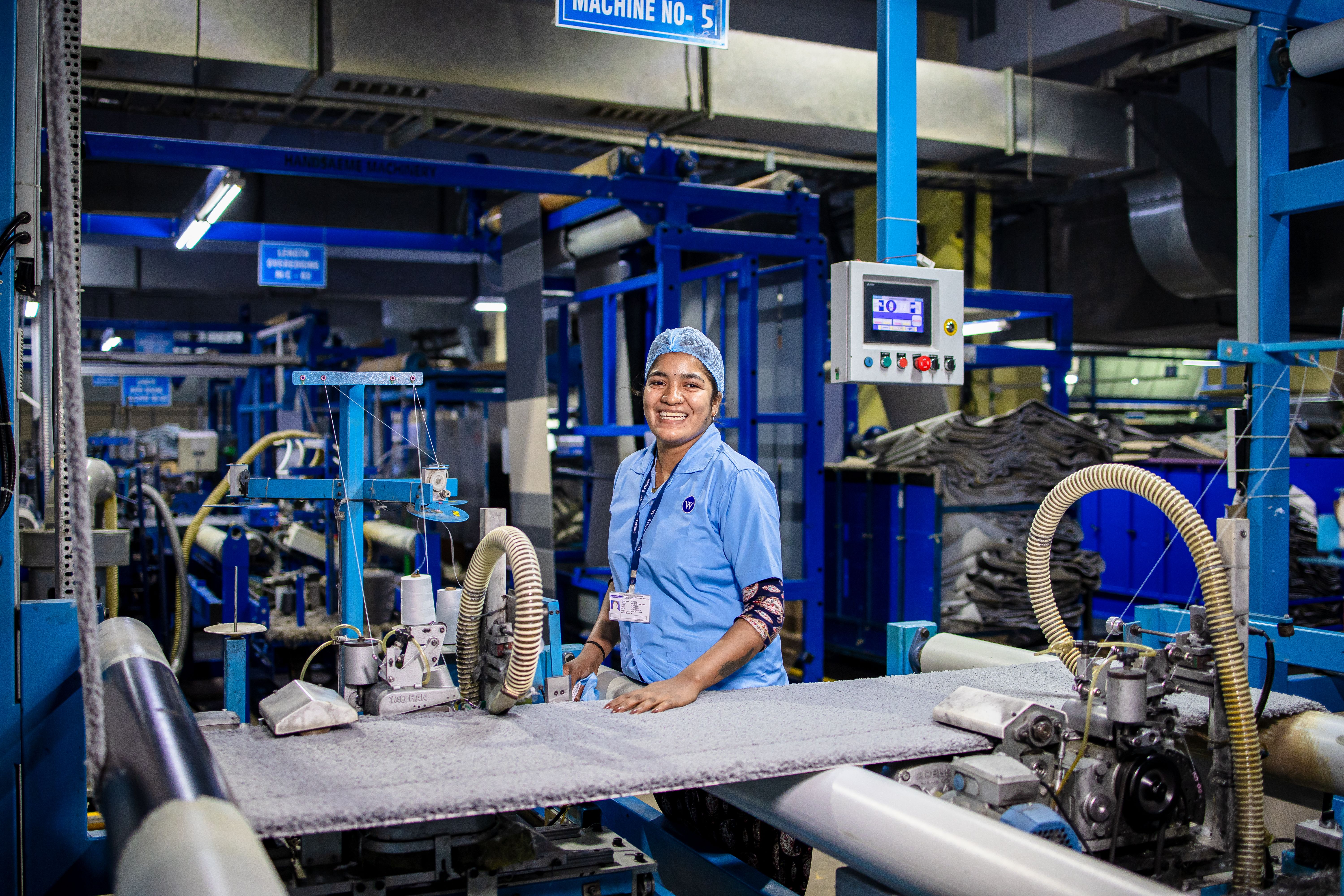 Smiling Factory Worker Operating Textile Machine · Free Stock Photo