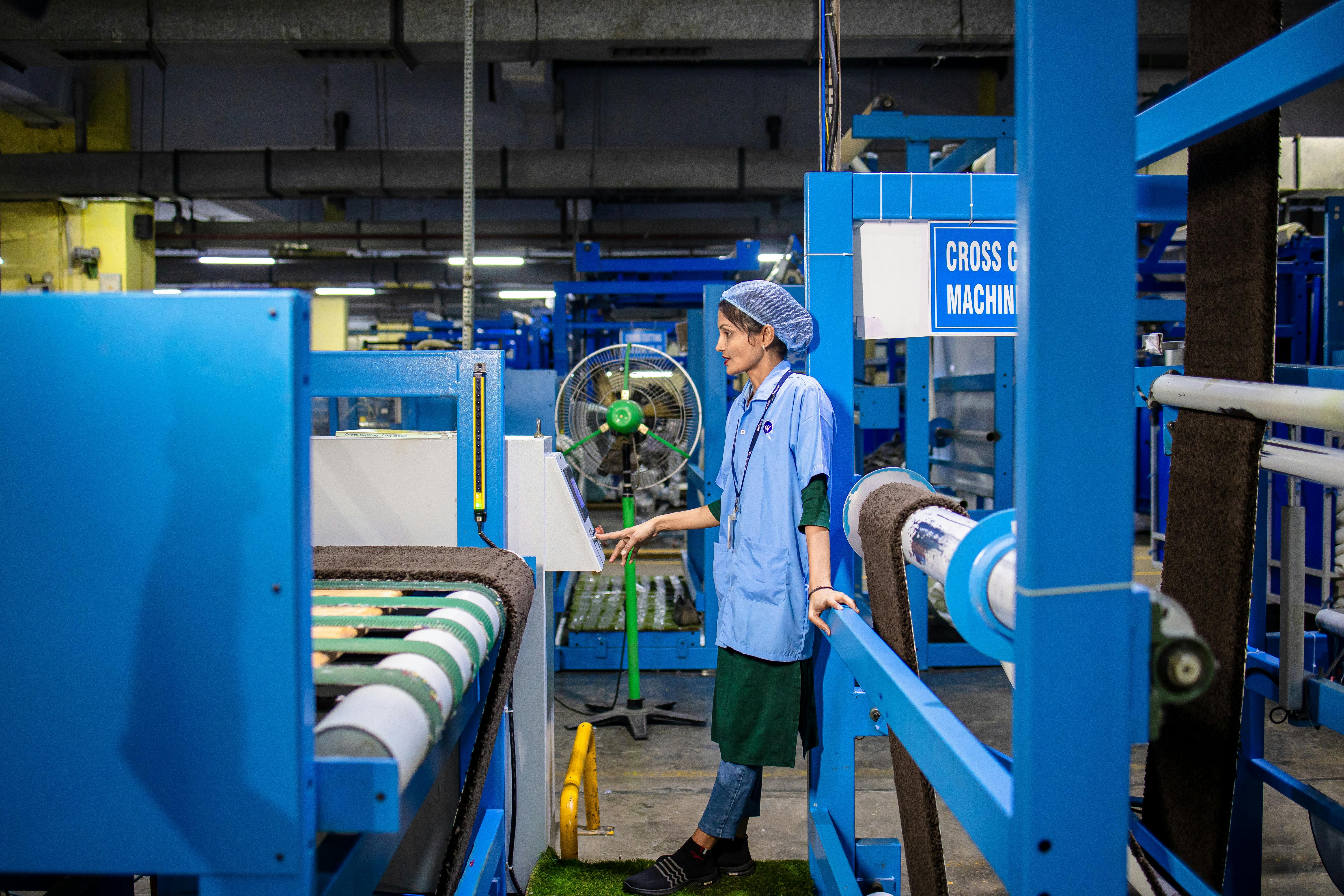 Female textile worker in industrial factory setting · Free Stock Photo