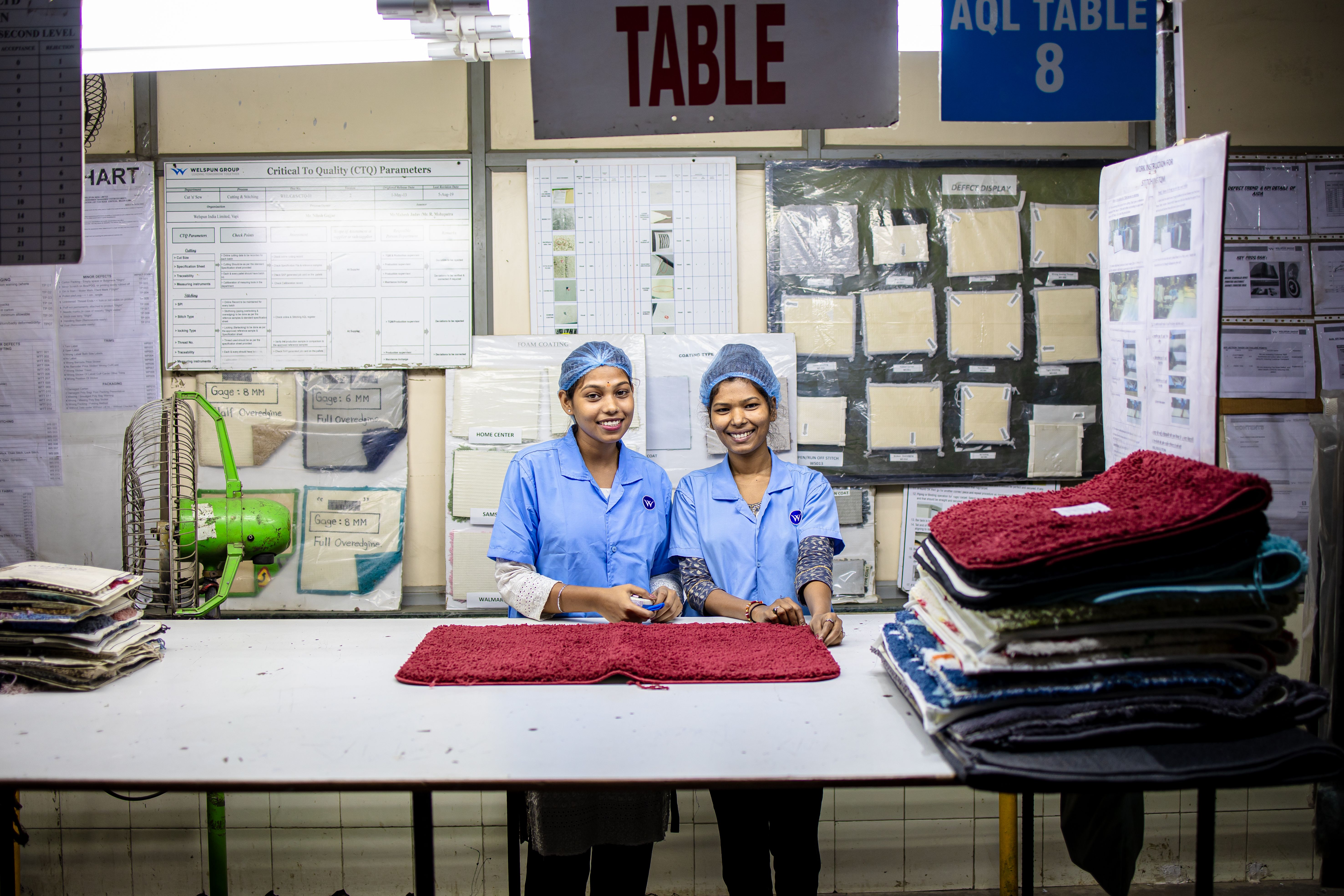 Smiling Workers in Textile Factory Setting · Free Stock Photo