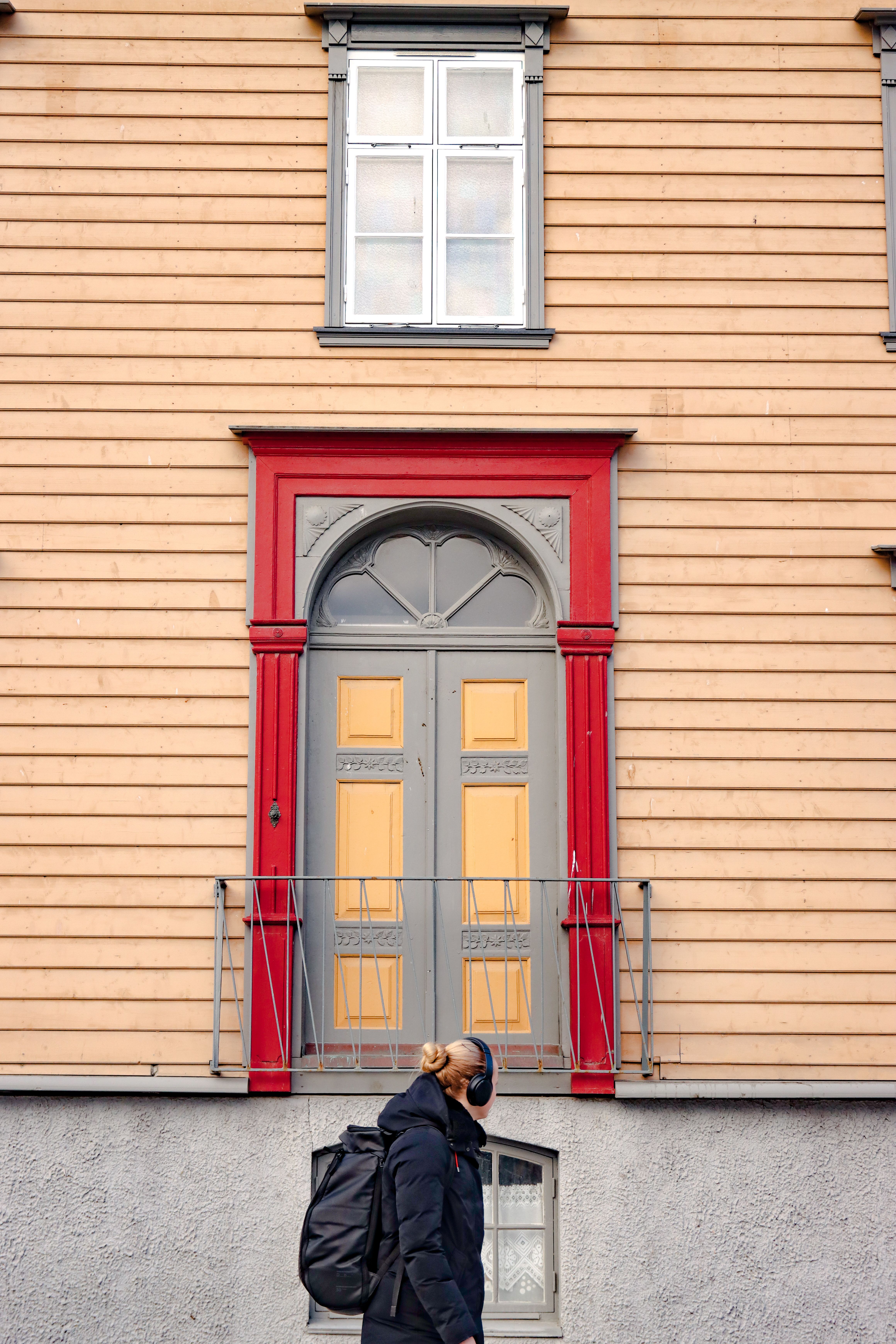 Person Walking by Colorful Wooden House in Tromsø · Free Stock Photo