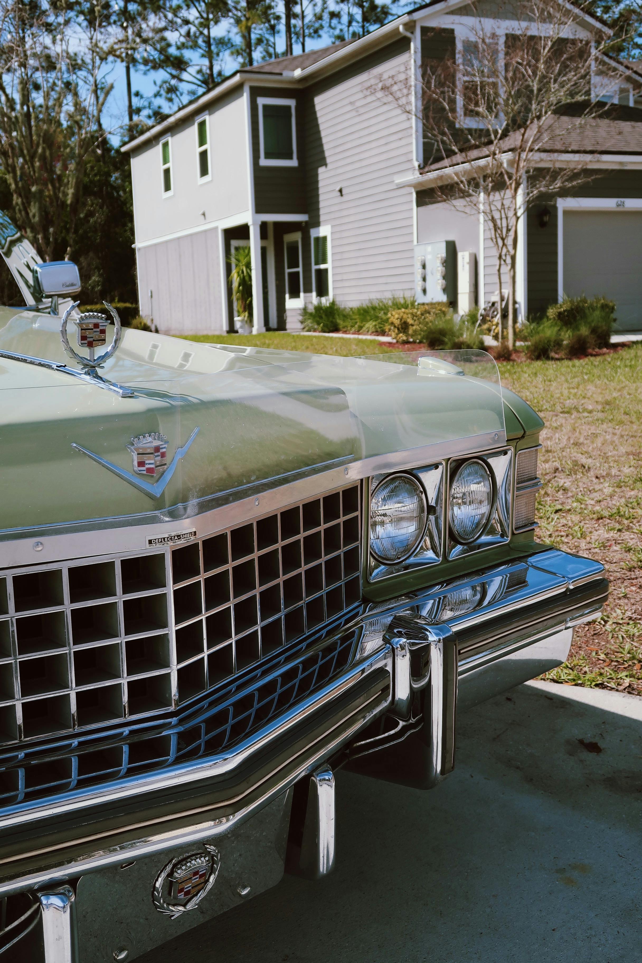 Vintage Cadillac in Suburban Neighborhood Driveway · Free Stock Photo