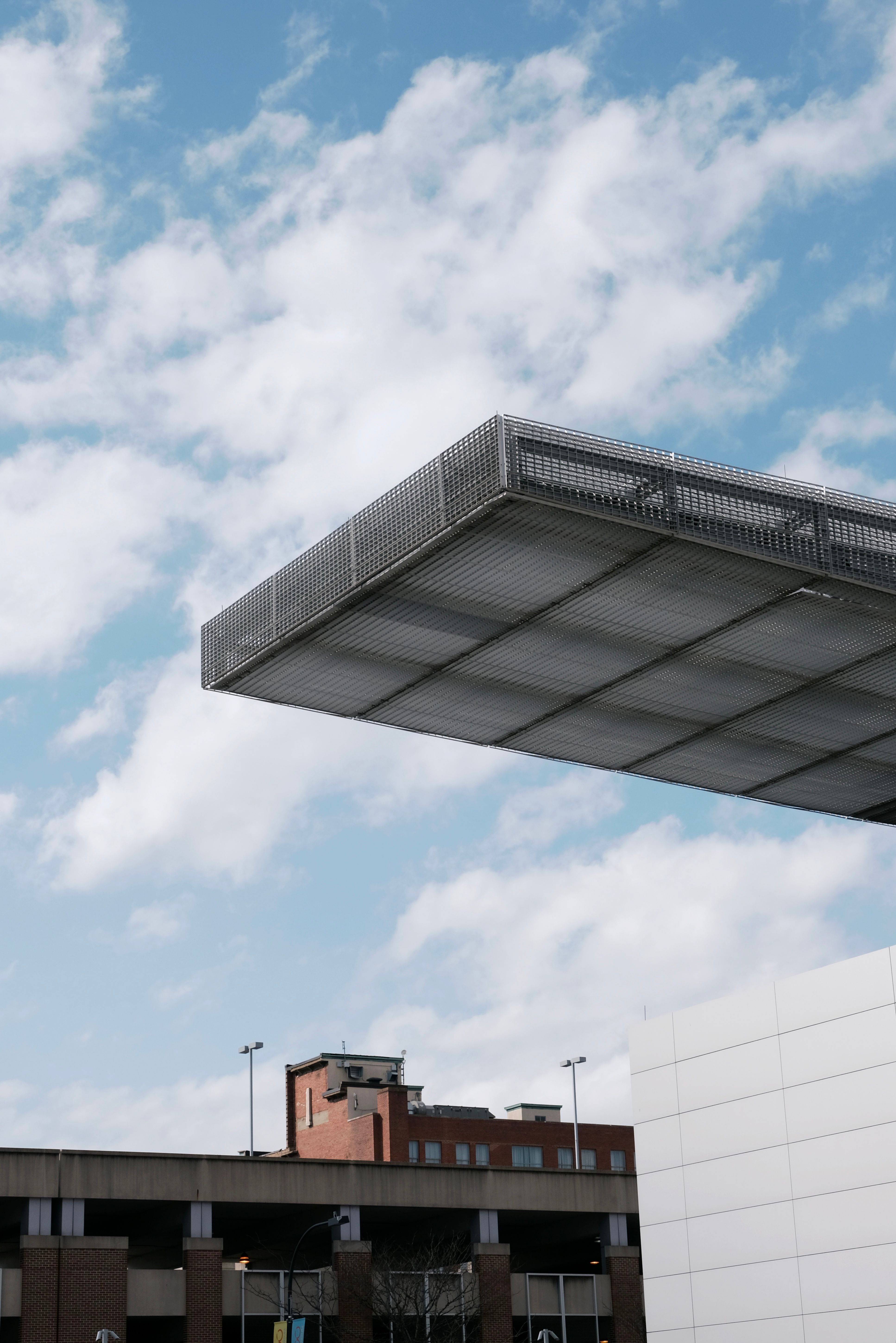 Modern architectural structure against cloudy sky · Free Stock Photo