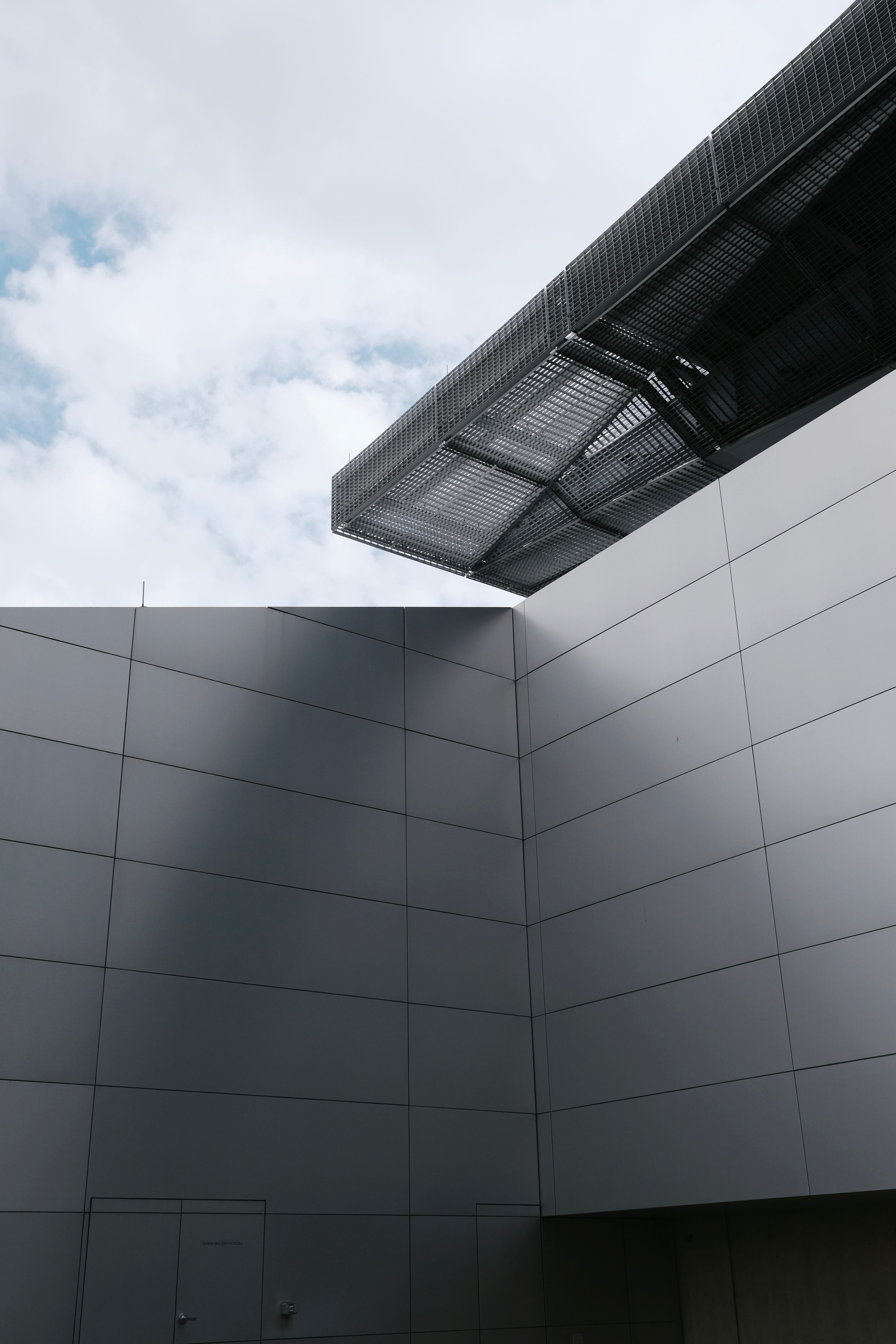 Modern Industrial Building with Metallic Roof Detail · Free Stock Photo