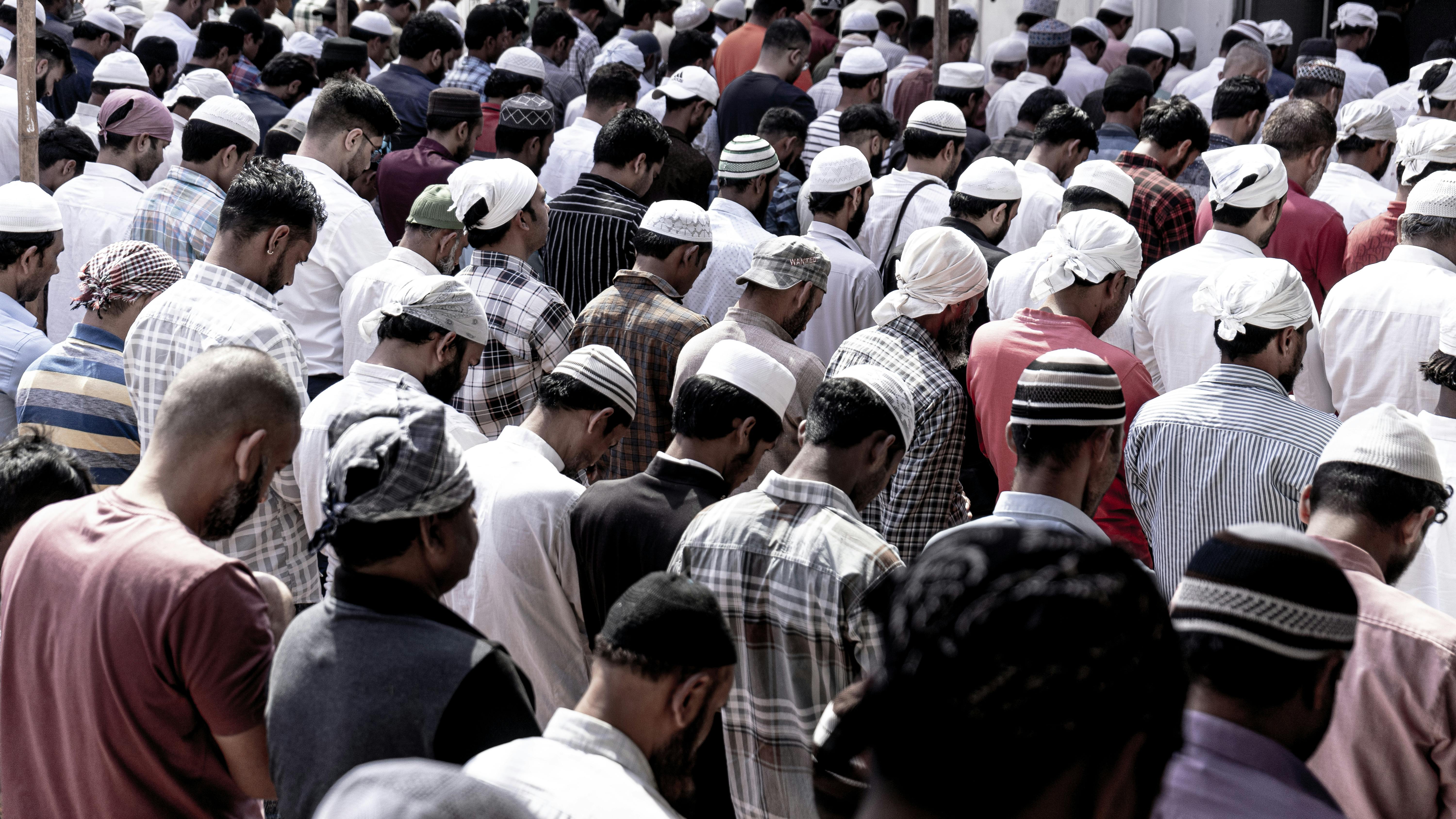 Gran Grupo De Hombres Orando Al Aire Libre · Foto de stock gratuita